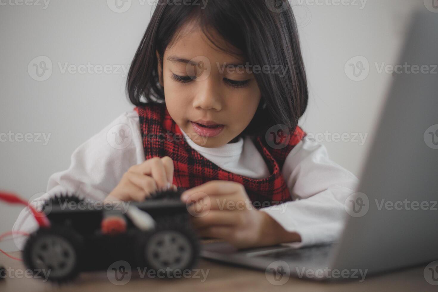 STEM education concept. Asian students learn at home by coding robot arms in STEM, mathematics ...