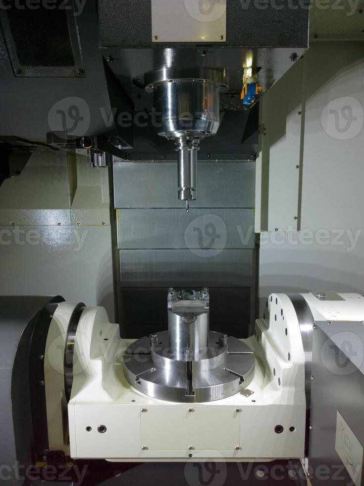 The five-axis Computer Numerical Control CNC machine waiting for stock ... The five-axis Computer Numerical Control CNC machine waiting for stock ...