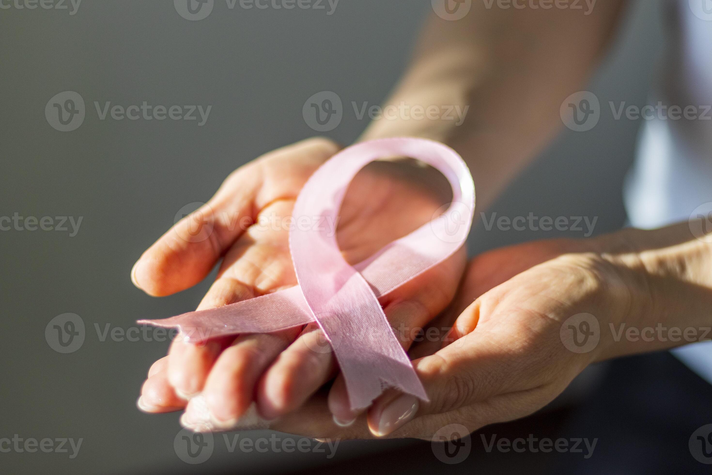 Shot Of A Woman Holding Pink Ribbon Symbol Of A Breast Cancer