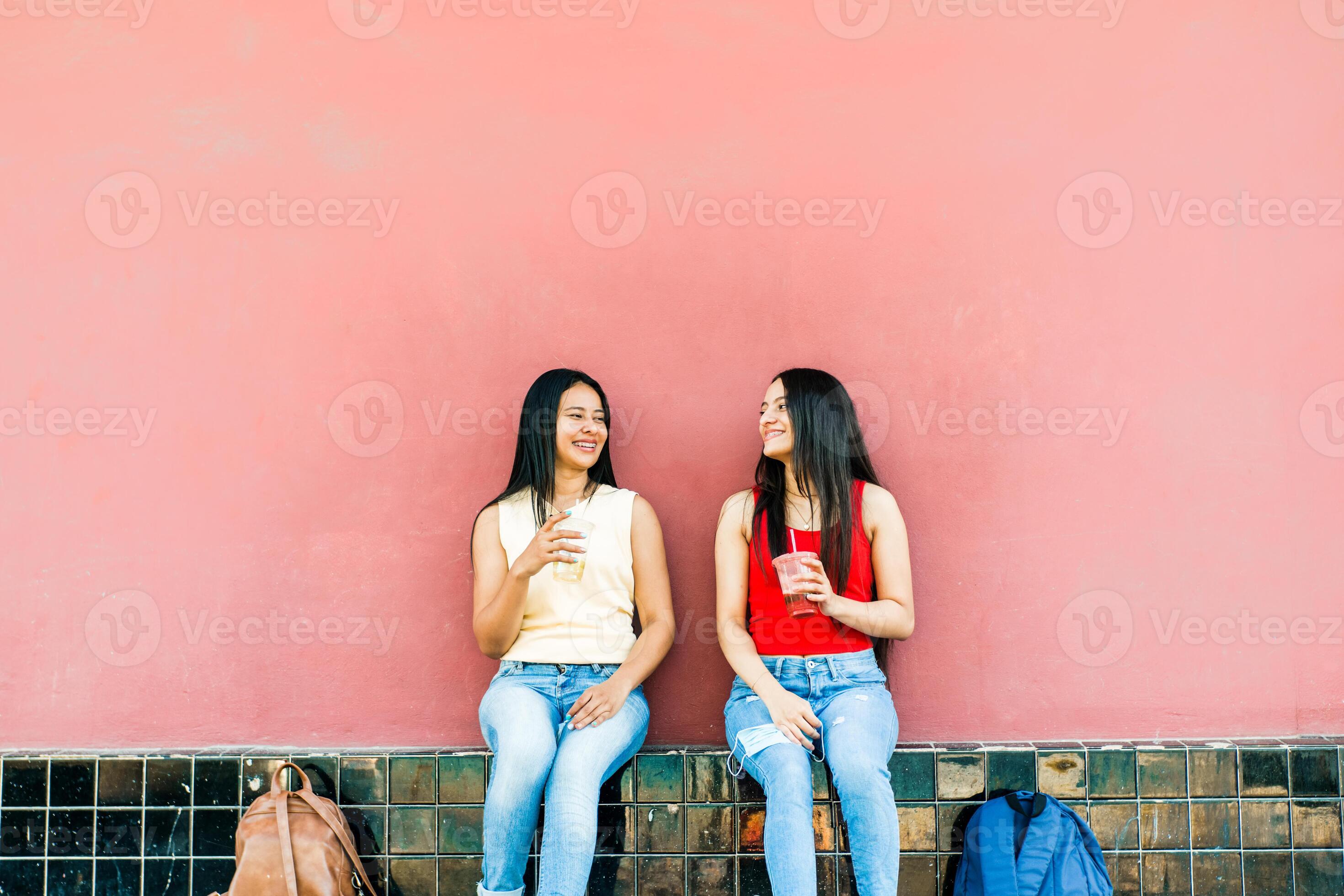Latin American Girl Friends Sitting While Talking Urban Concept And