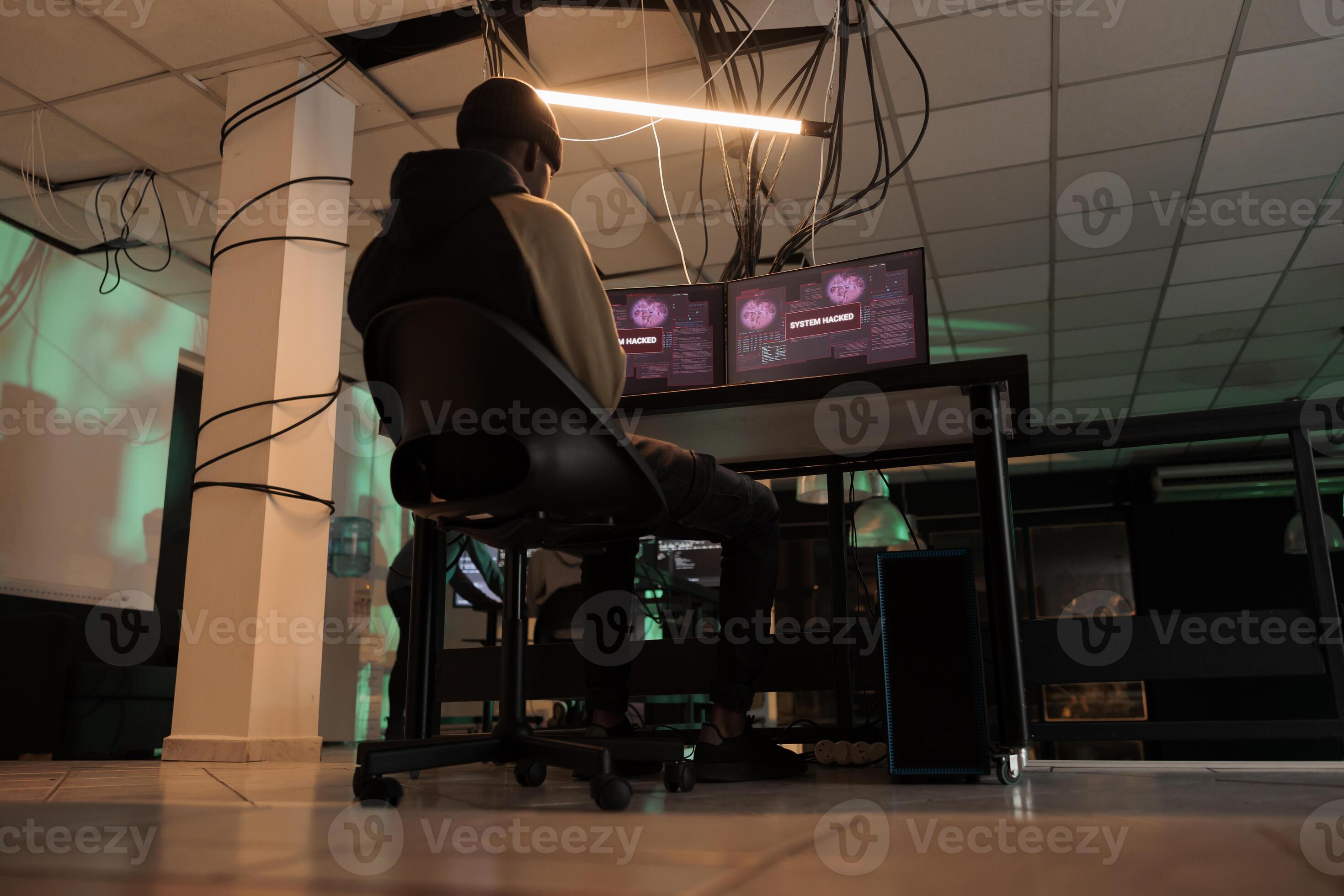 Professional hacker using encryption to break system, working on multiple monitors at night ...