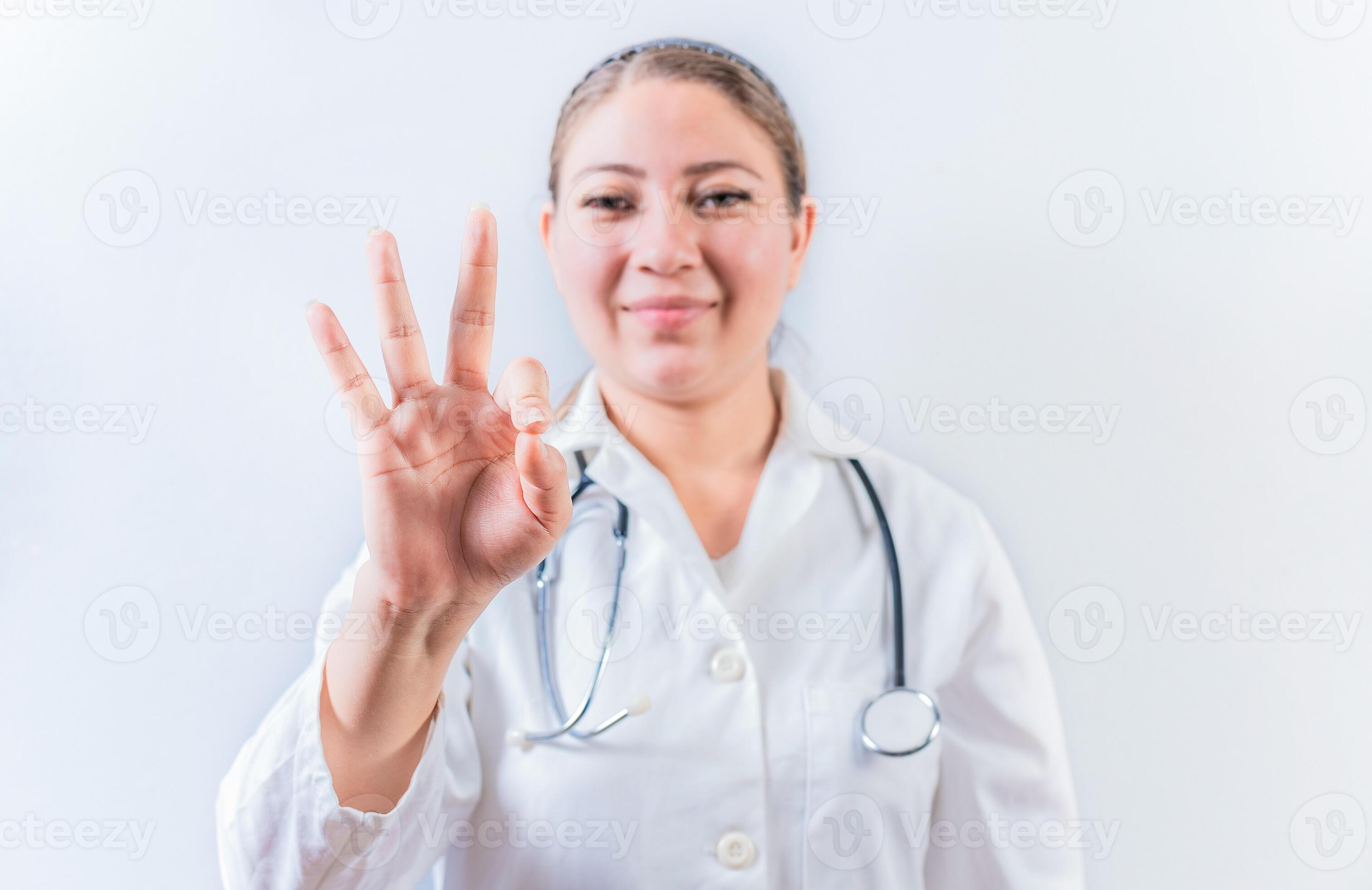 Female doctor counting number THREE isolated. Young female doctor ... Female doctor counting number THREE isolated. Young female doctor ...