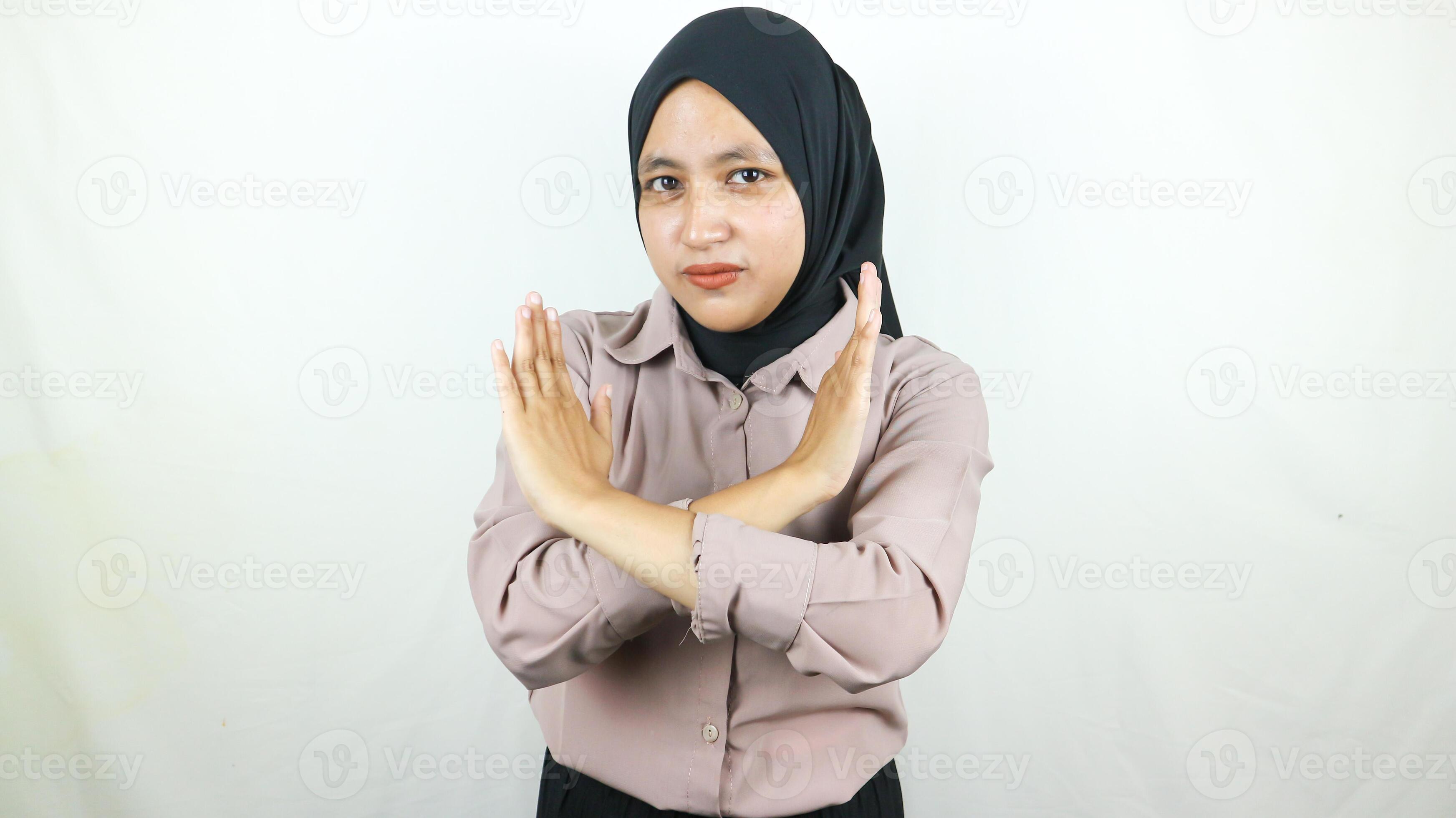 Serious muslim woman showing stop, cross arms gesture, frownign displeased, disapprove something ...