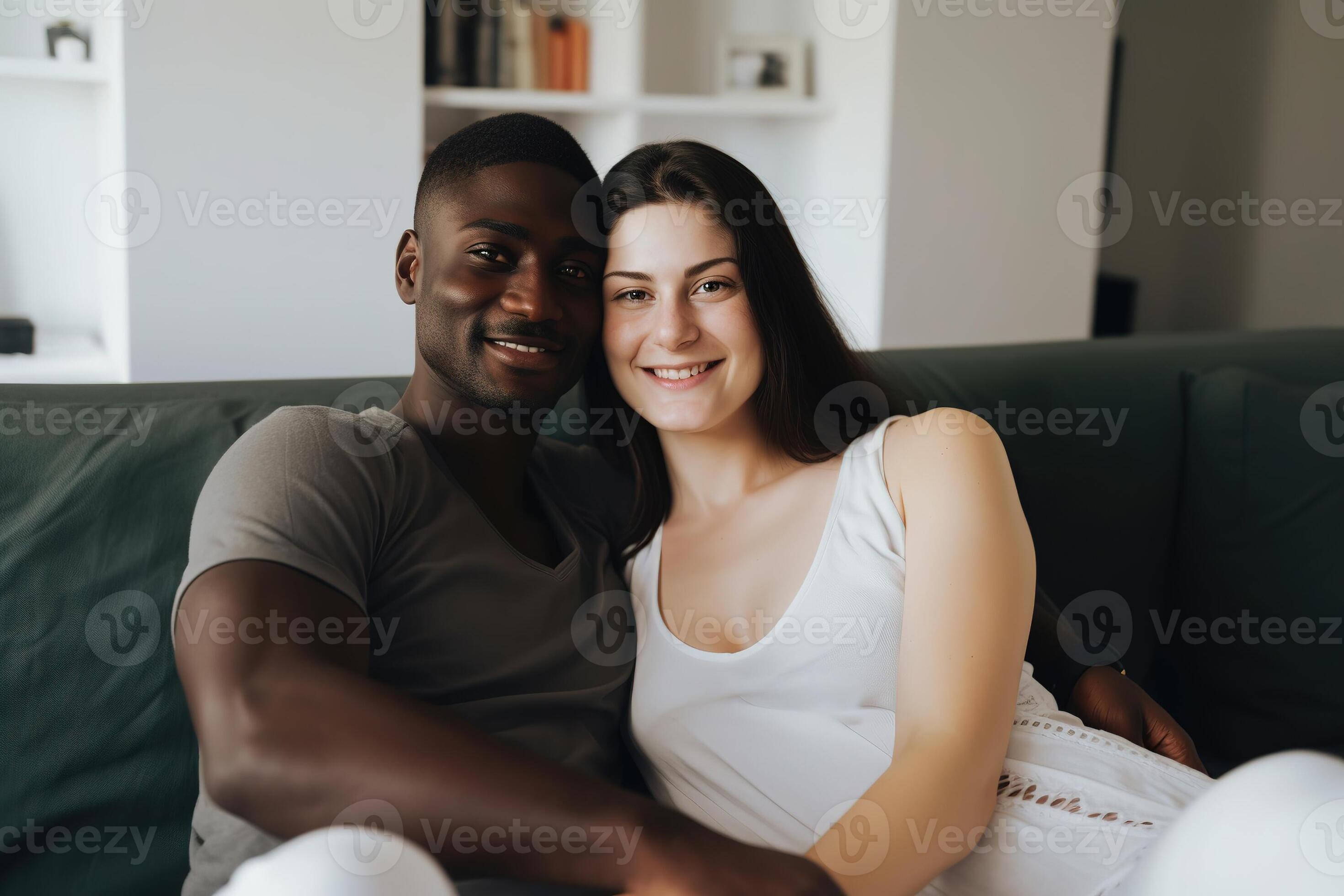 AI Generated Interracial couple smiling and sitting closely on the couch 39372615 Stock Photo at ...