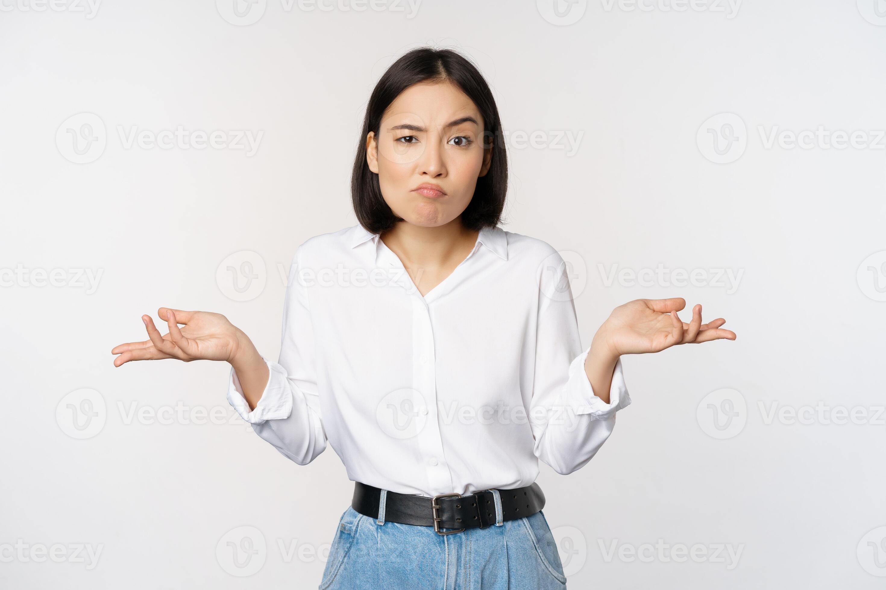 Image of confused asian office manager, office lady shrugging shoulders ...