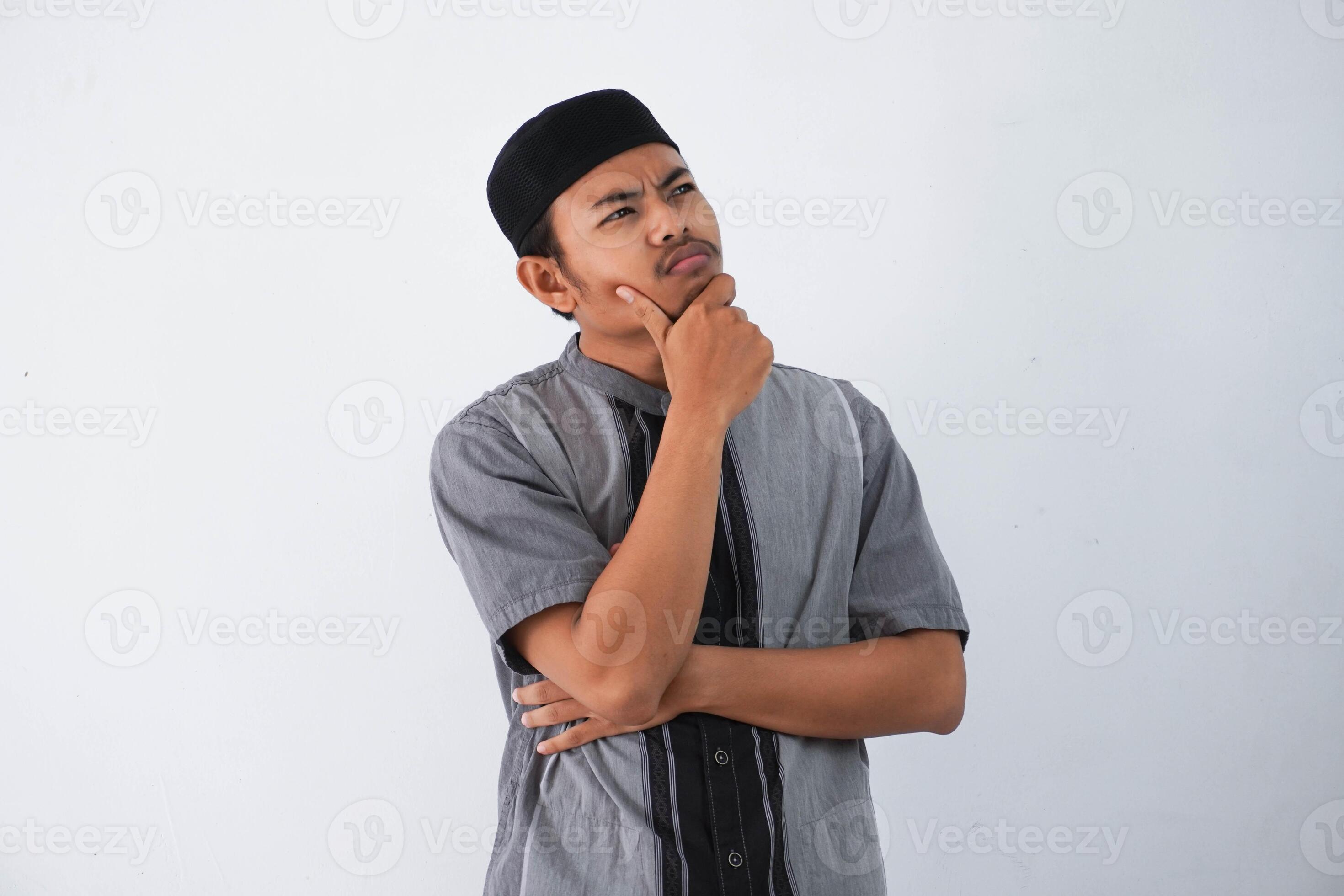 thinking young asian muslim man holding chin thinking gesture, looking ...