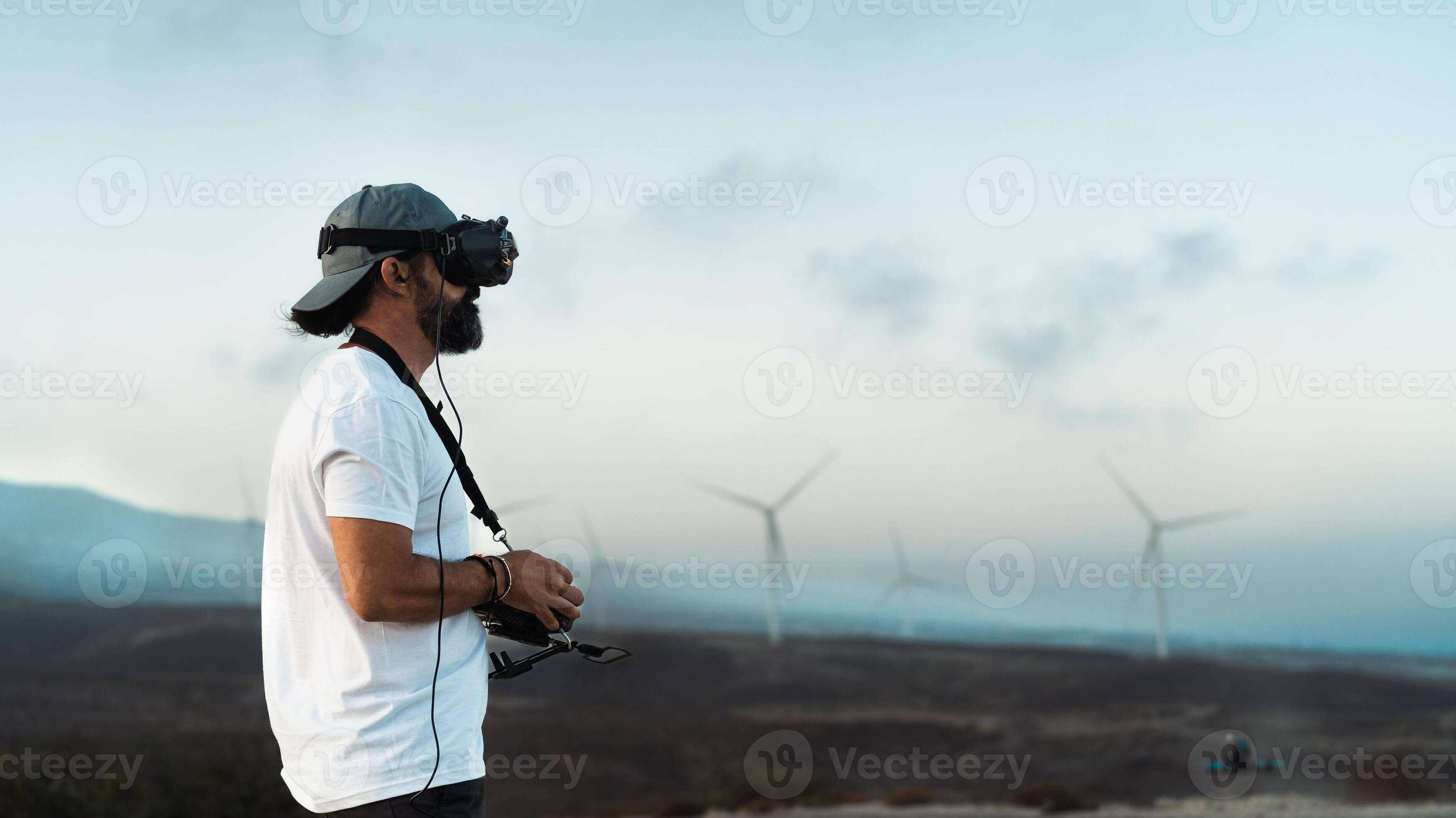Drone engineer using first person view technology on the turbine farm - Alternative energy and ...