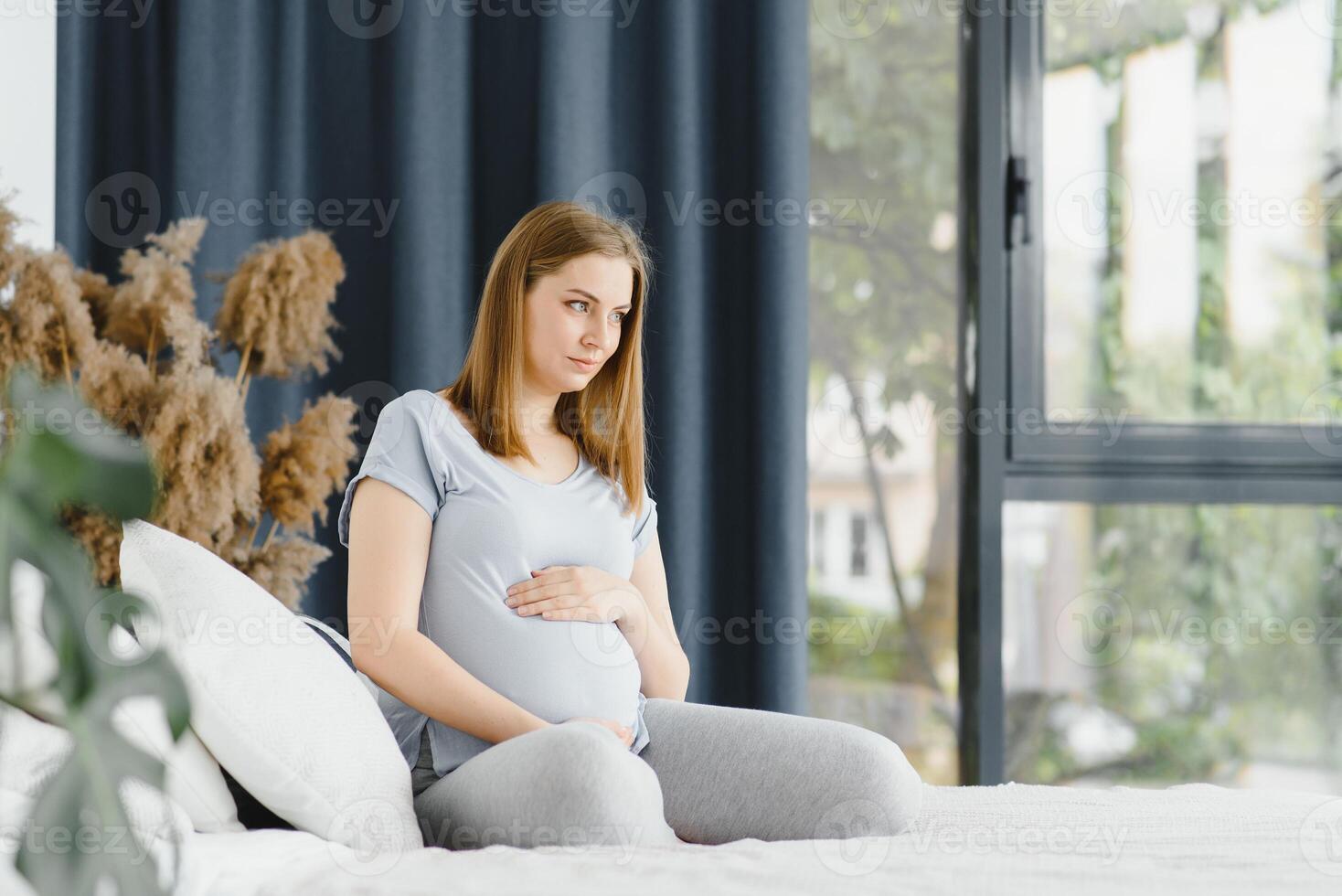 Beautiful Pregnant Woman Holds Hands On Belly In Bedroom At Home Young