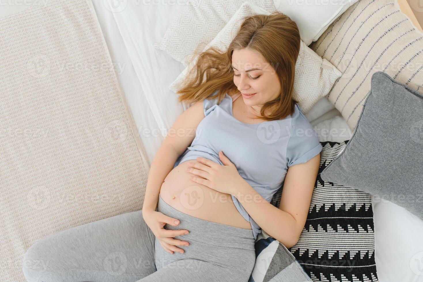 Beautiful Pregnant Woman Holds Hands On Belly In Bedroom At Home Young