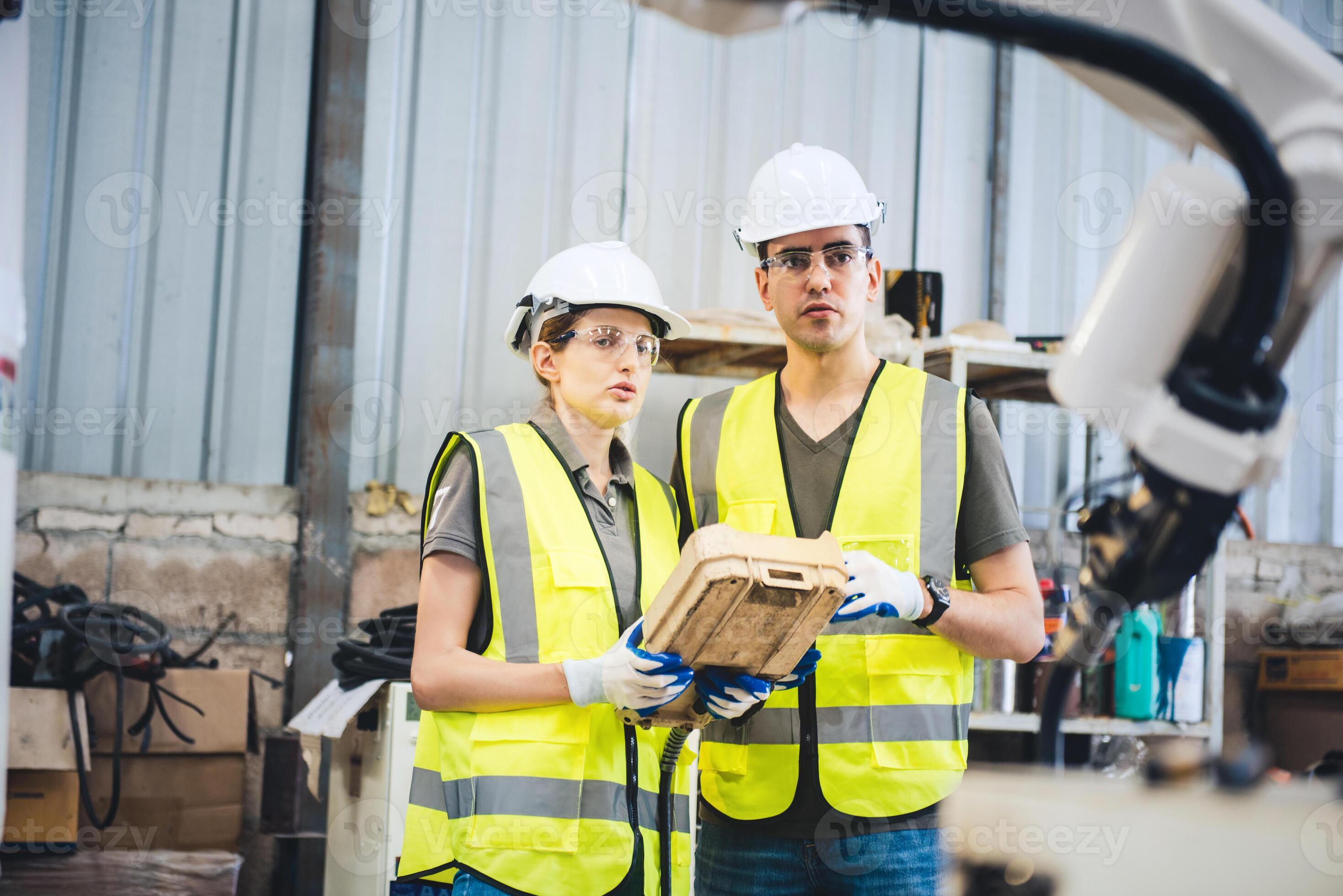 Engineers team mechanic using computer controller Robotic arm for ...