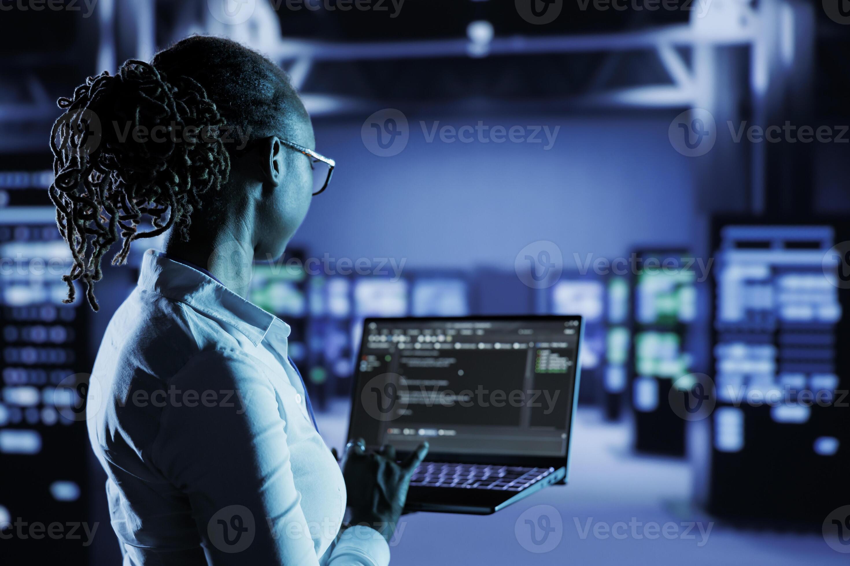 Licensed programmer running code and programming on laptop, troubleshooting and upgrading high ...