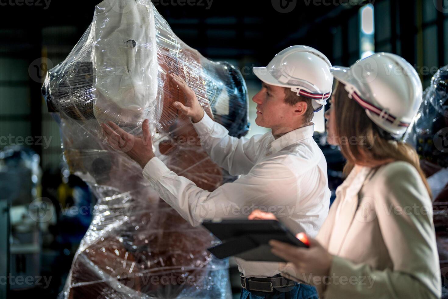 Sales manager and factory owner in suits negotiating selling robots used in the factory ...
