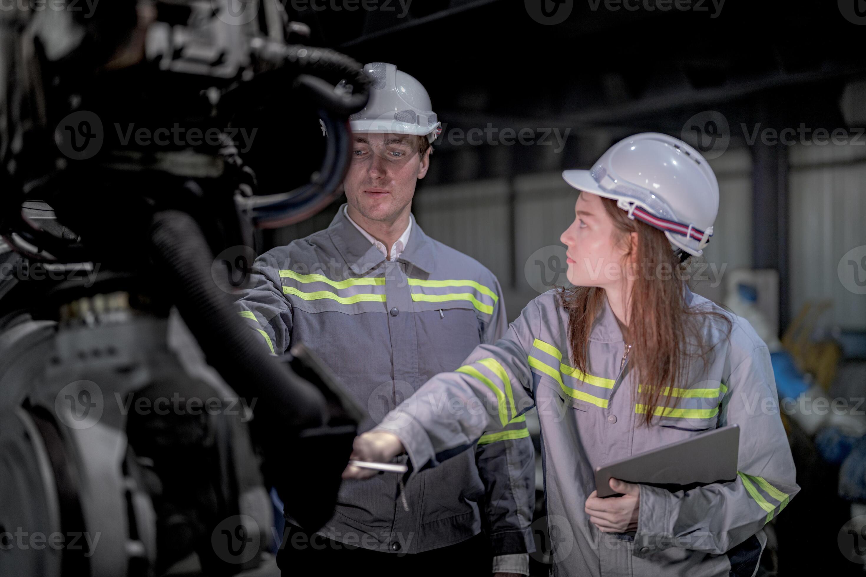 Business engineers meet and check control heavy machine robot arm ...