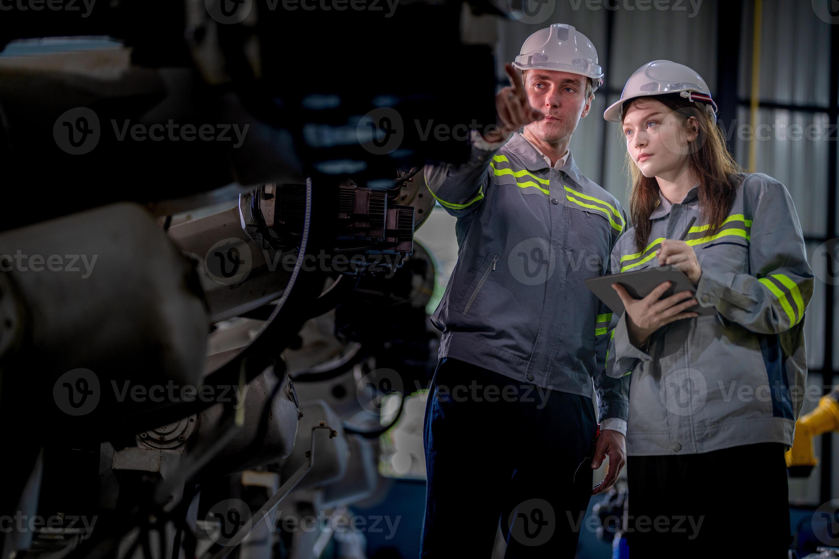 engineers check control heavy machine robot arm. Diverse Team of ...