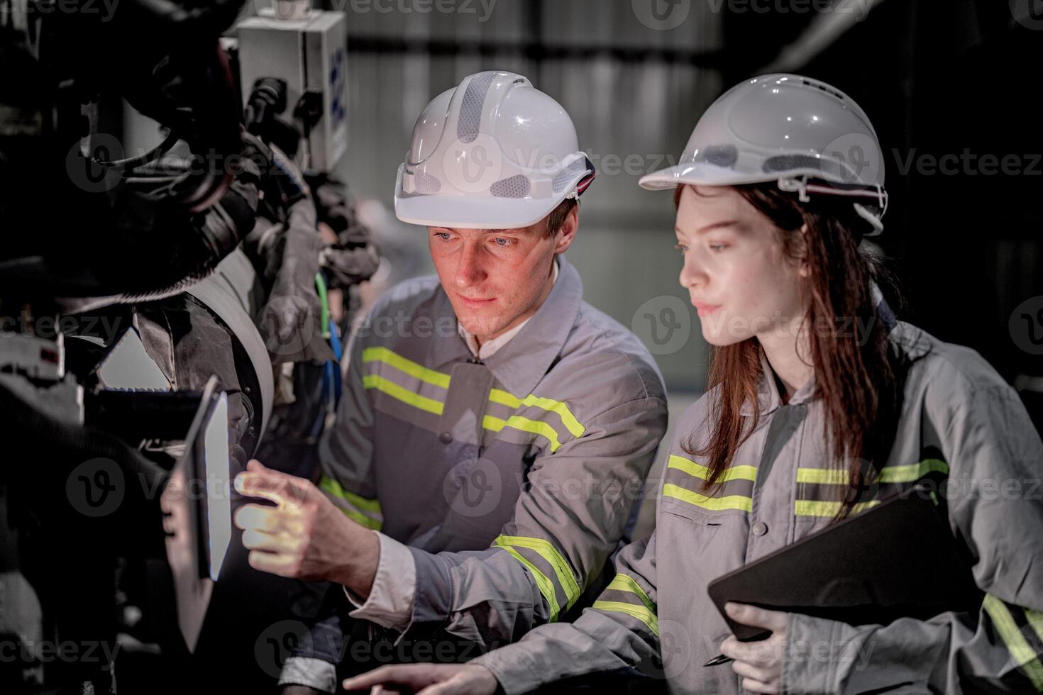 Business engineers meet and check control heavy machine robot arm ...