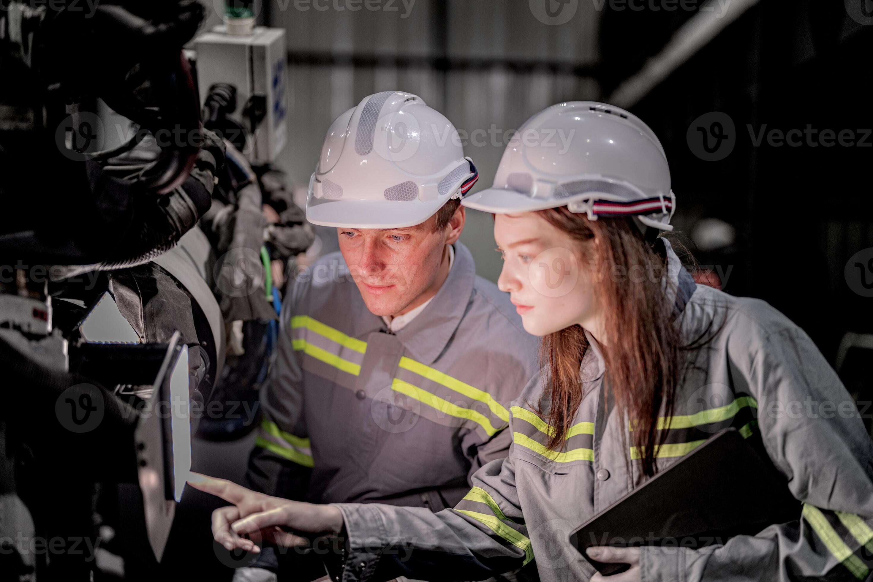 Business engineers meet and check control heavy machine robot arm ...