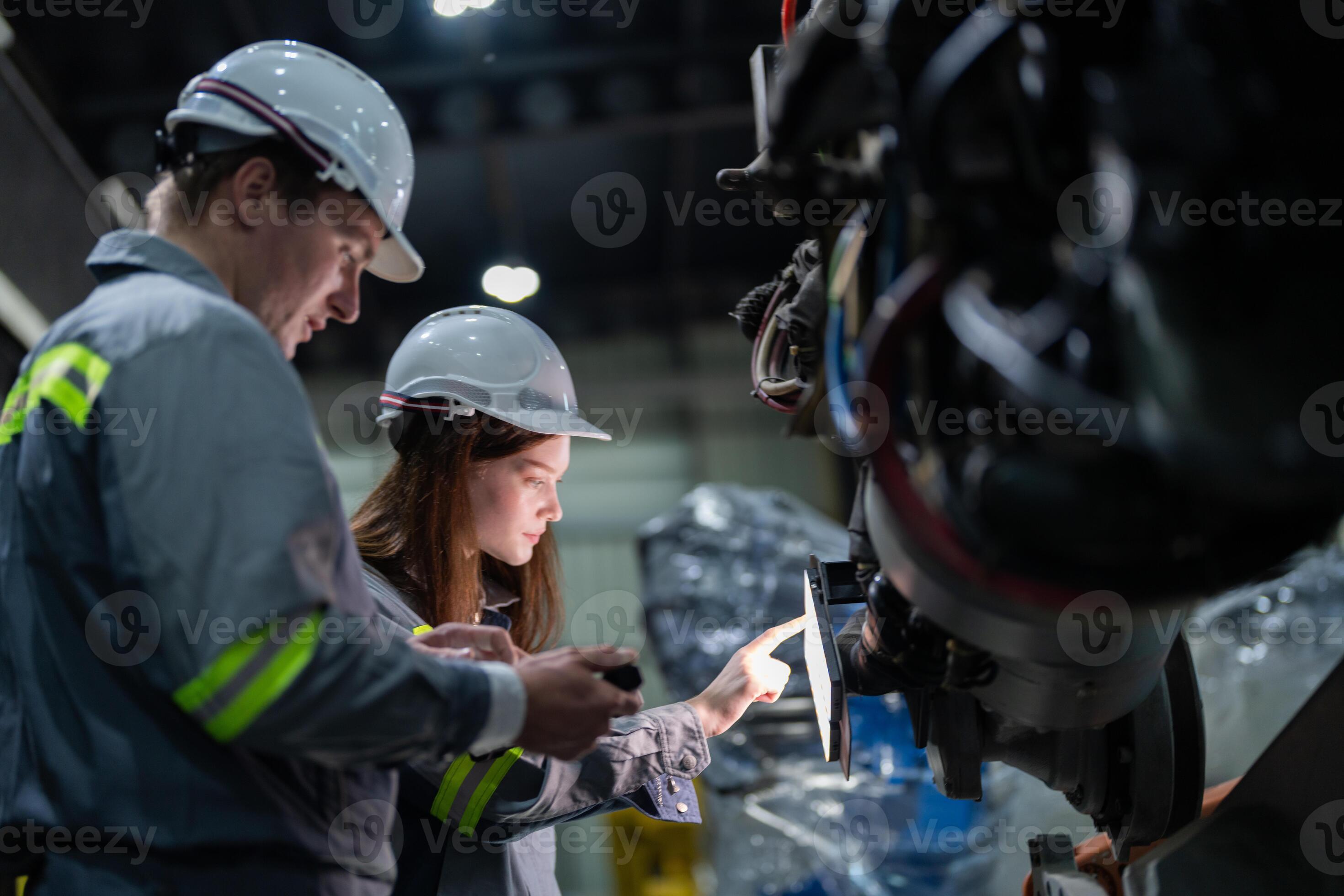 engineers check control heavy machine robot arm. Diverse Team of ...