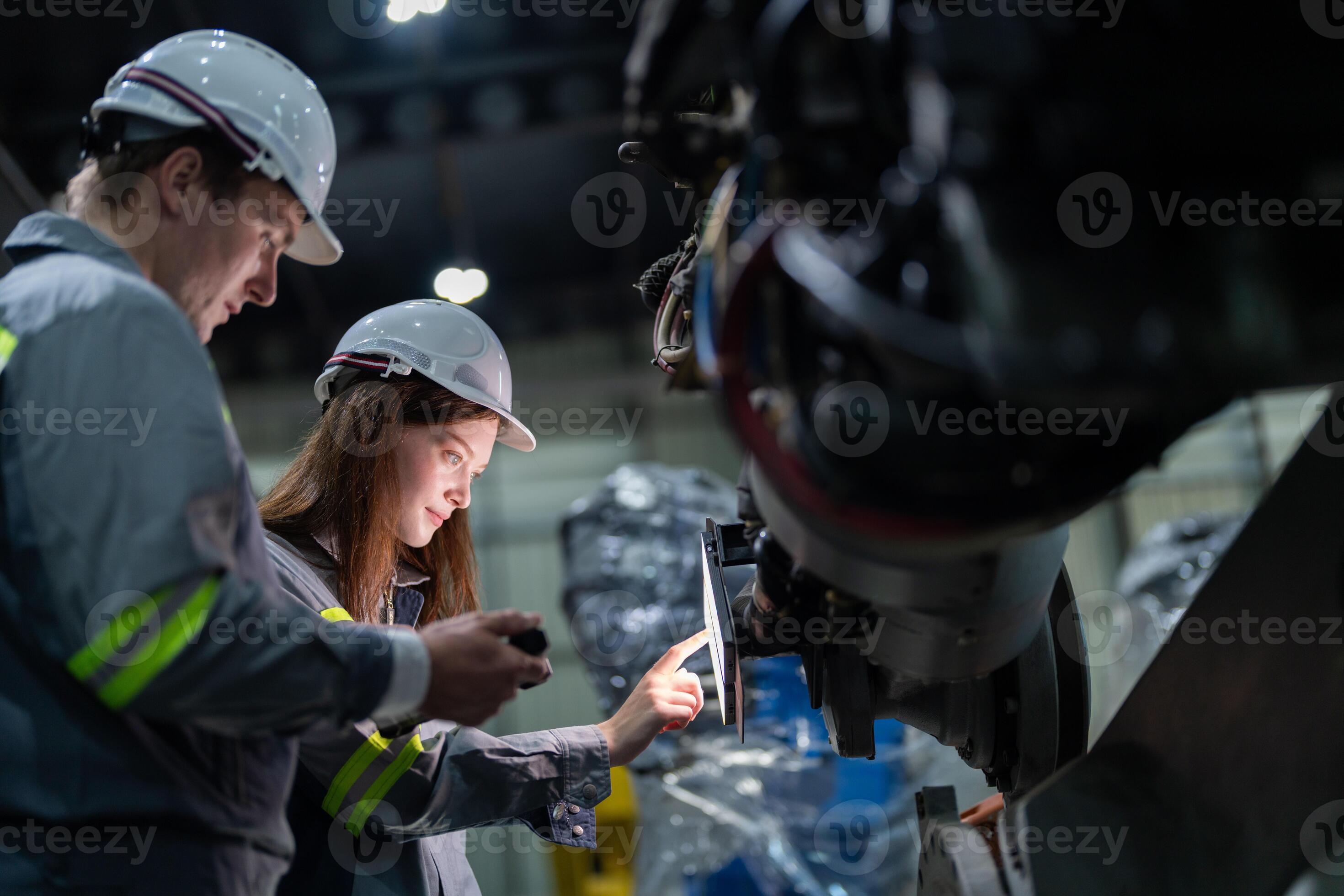 engineers check control heavy machine robot arm. Diverse Team of ...