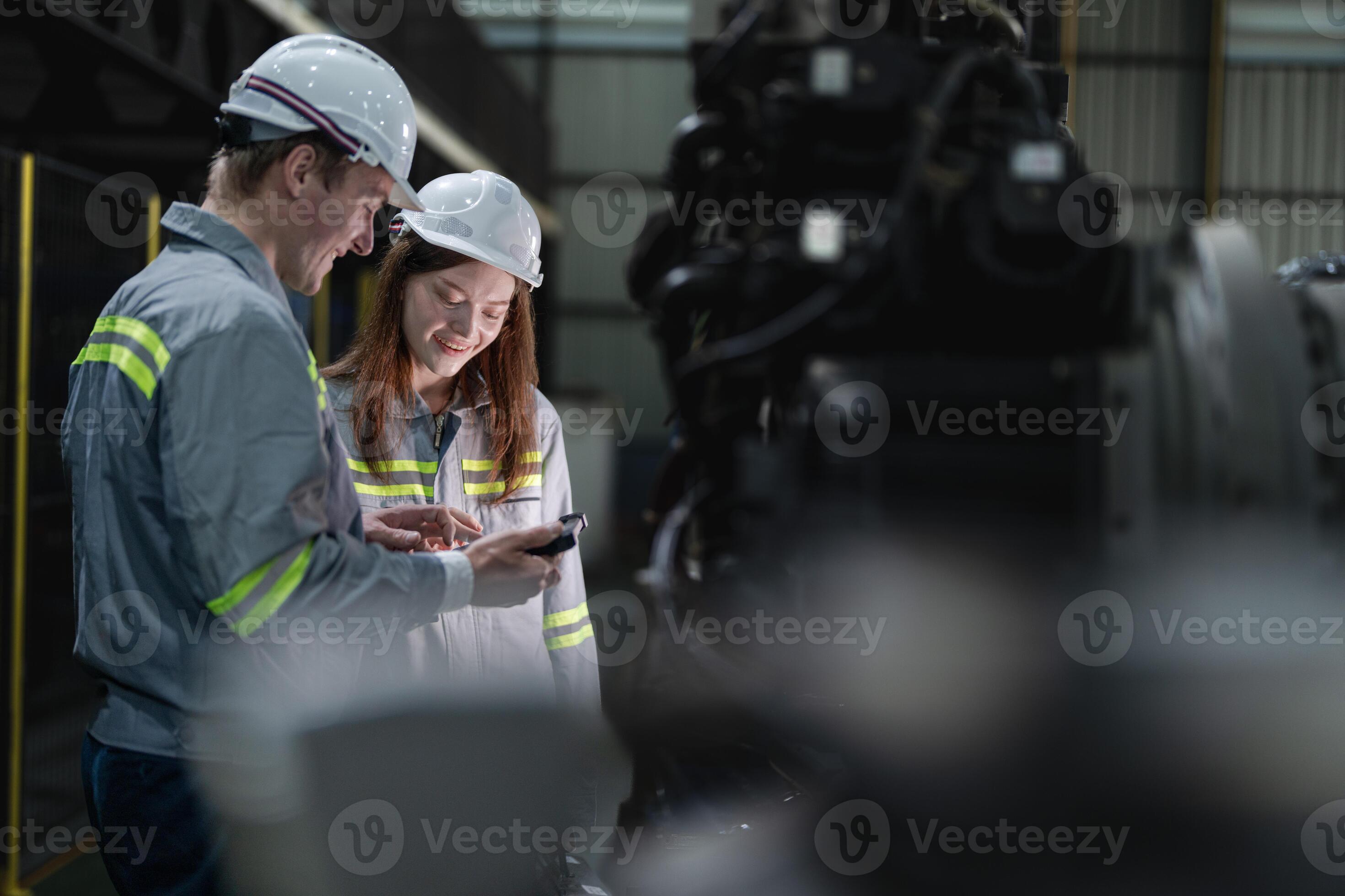 engineers check control heavy machine robot arm. Diverse Team of ...