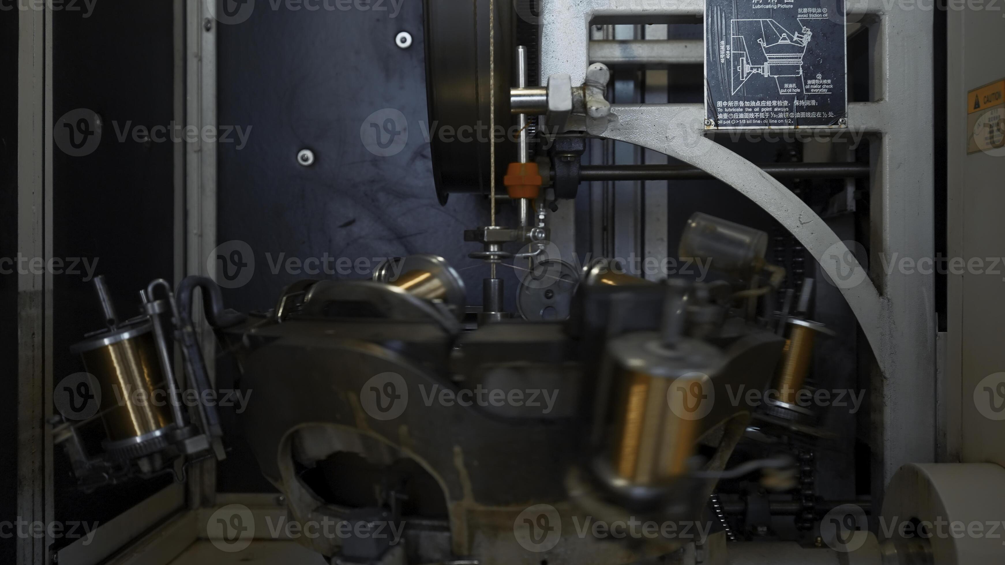 Automated machine with rotating coils and wire. Creative. Coils rotate on stack with winding ...