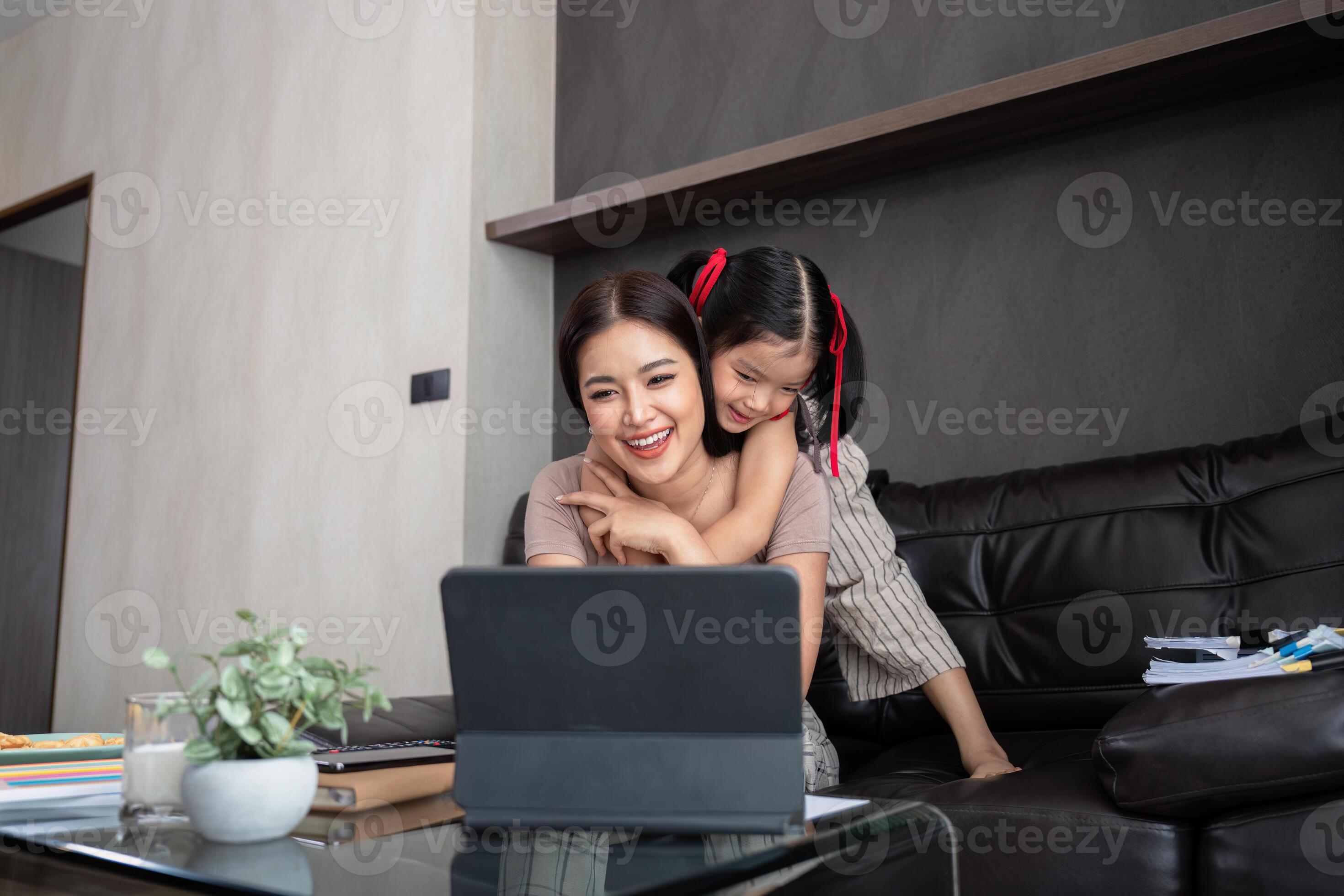 Cute active naughty girl noisy child plays with mom hugs mother attention from mom. woman work ...