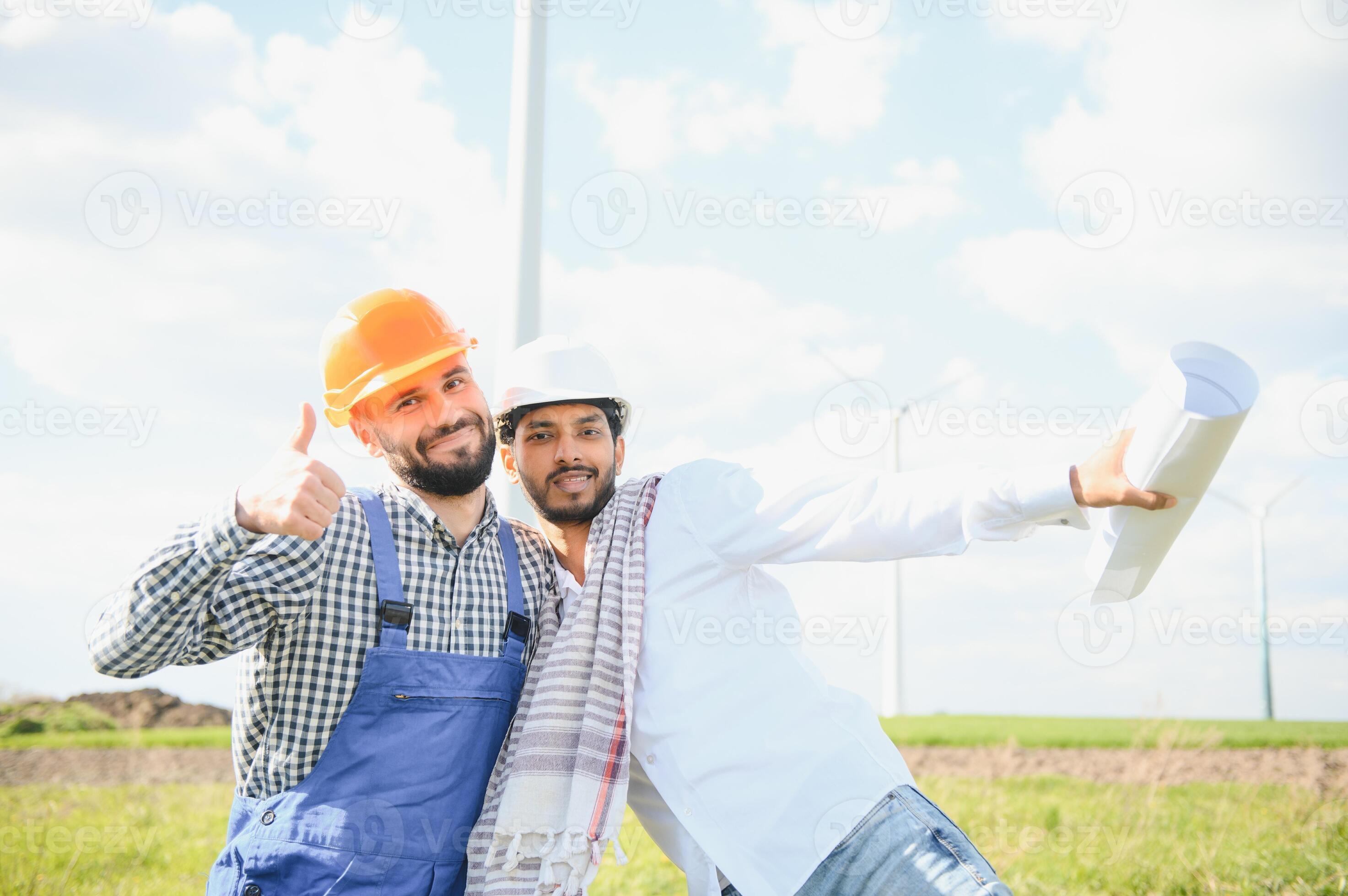 Two Engineers Discussing Against Turbines On Wind Turbine Farm