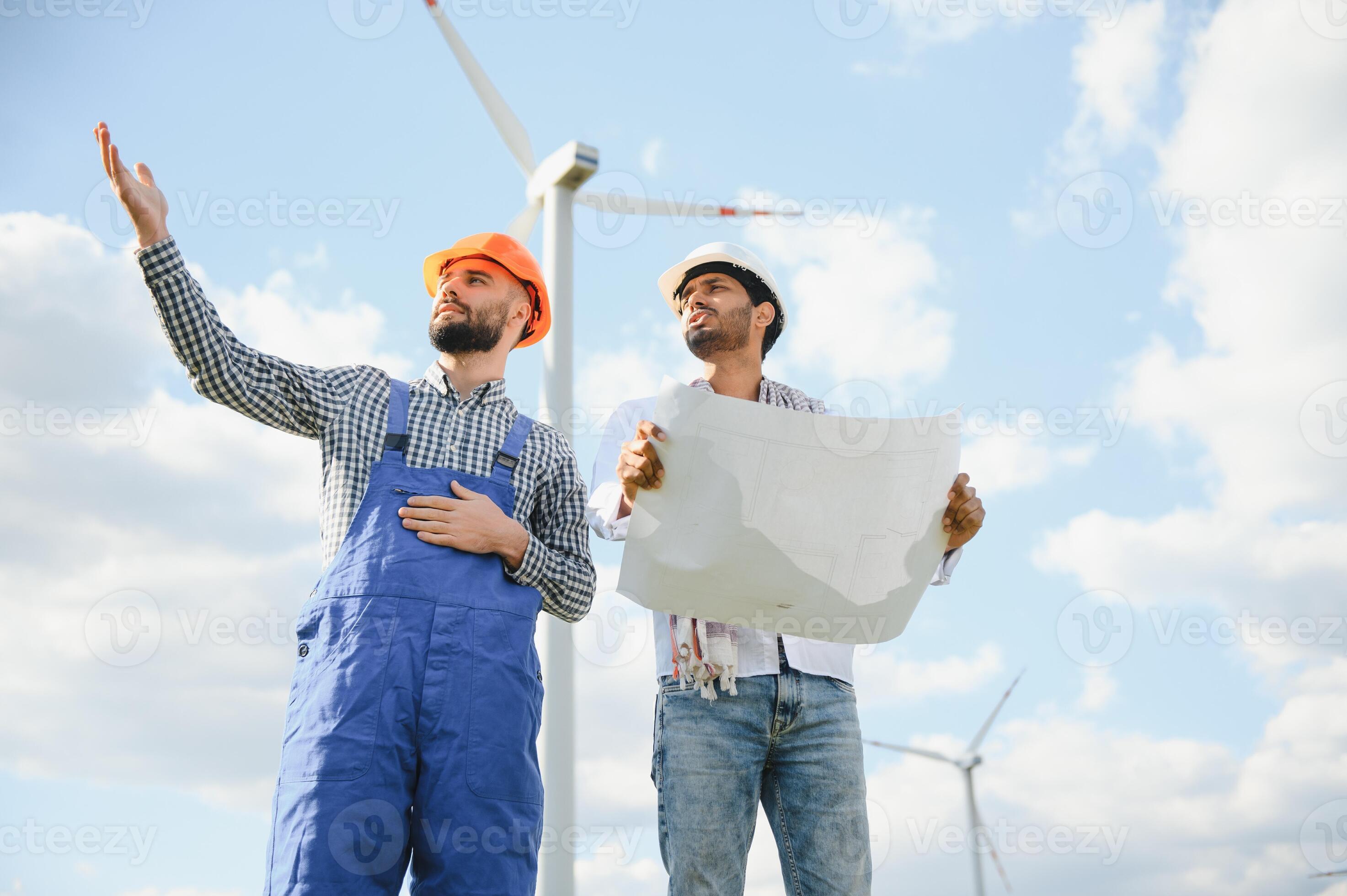 Two Engineers Discussing Against Turbines On Wind Turbine Farm