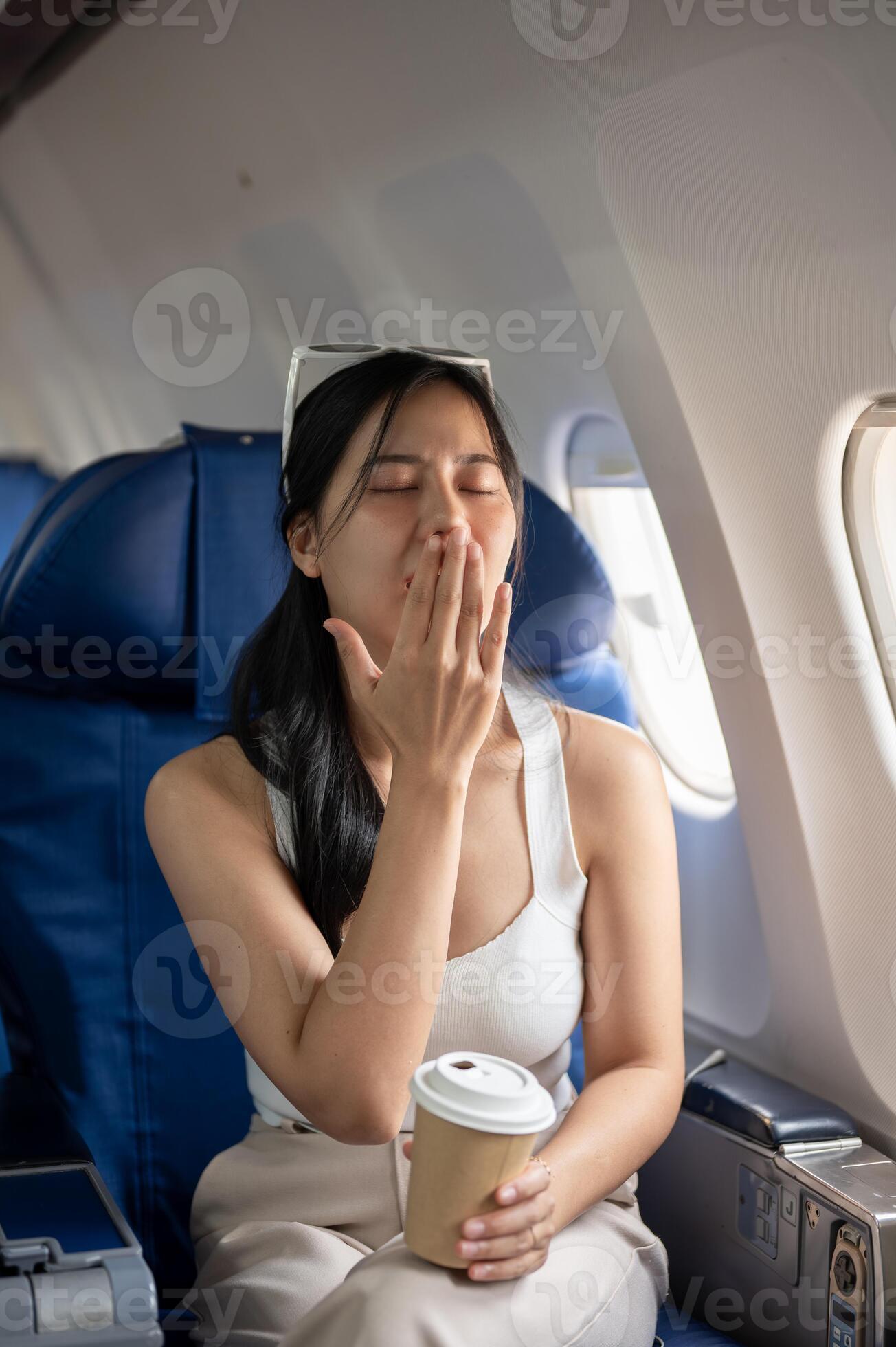 A Female Passenger Is Feeling Tired And Sleepy During A Long Flight