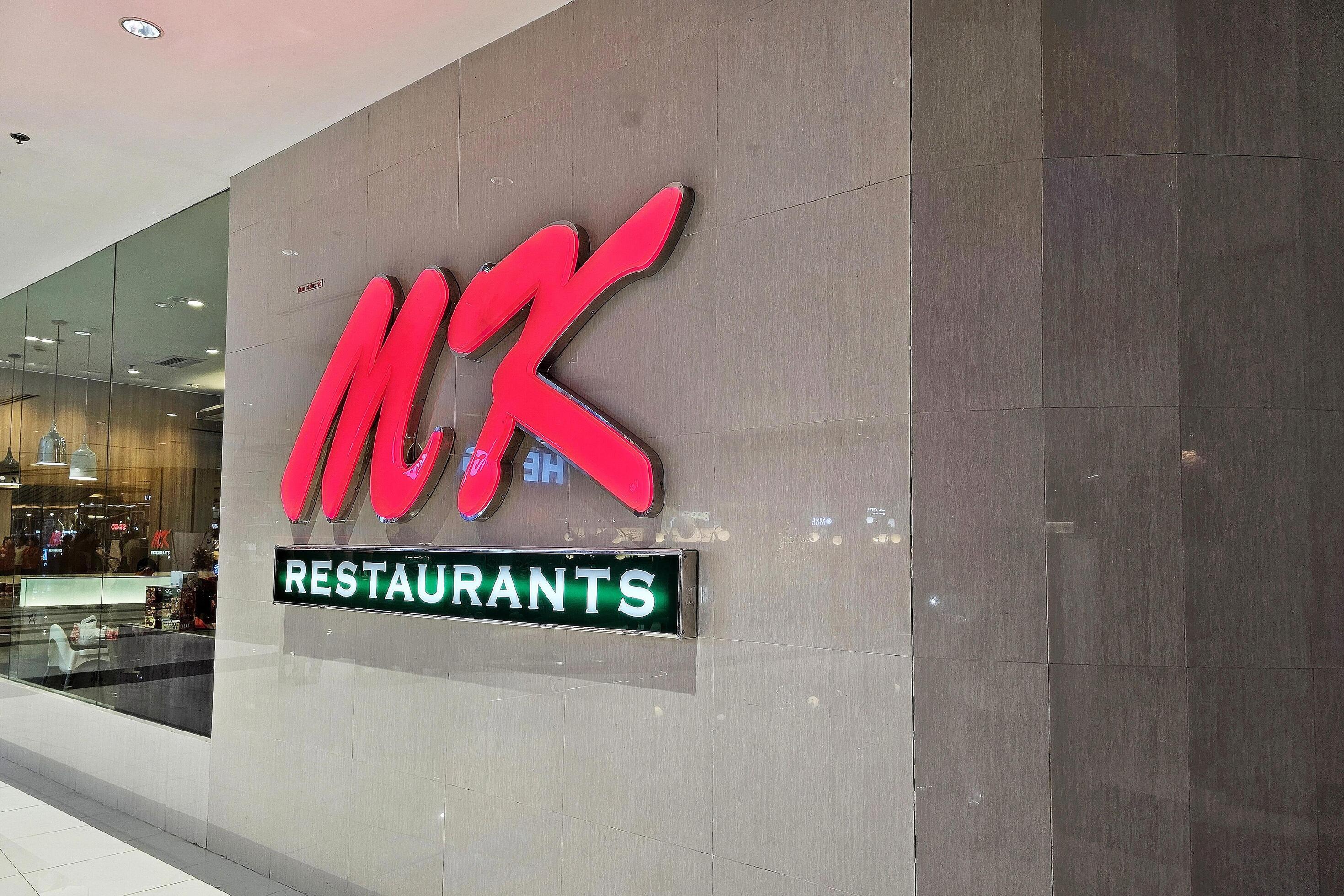 Bangkok, Thailand February 09, 2024 MK restaurants sign. MK is a famous suki chains in Thailand ...