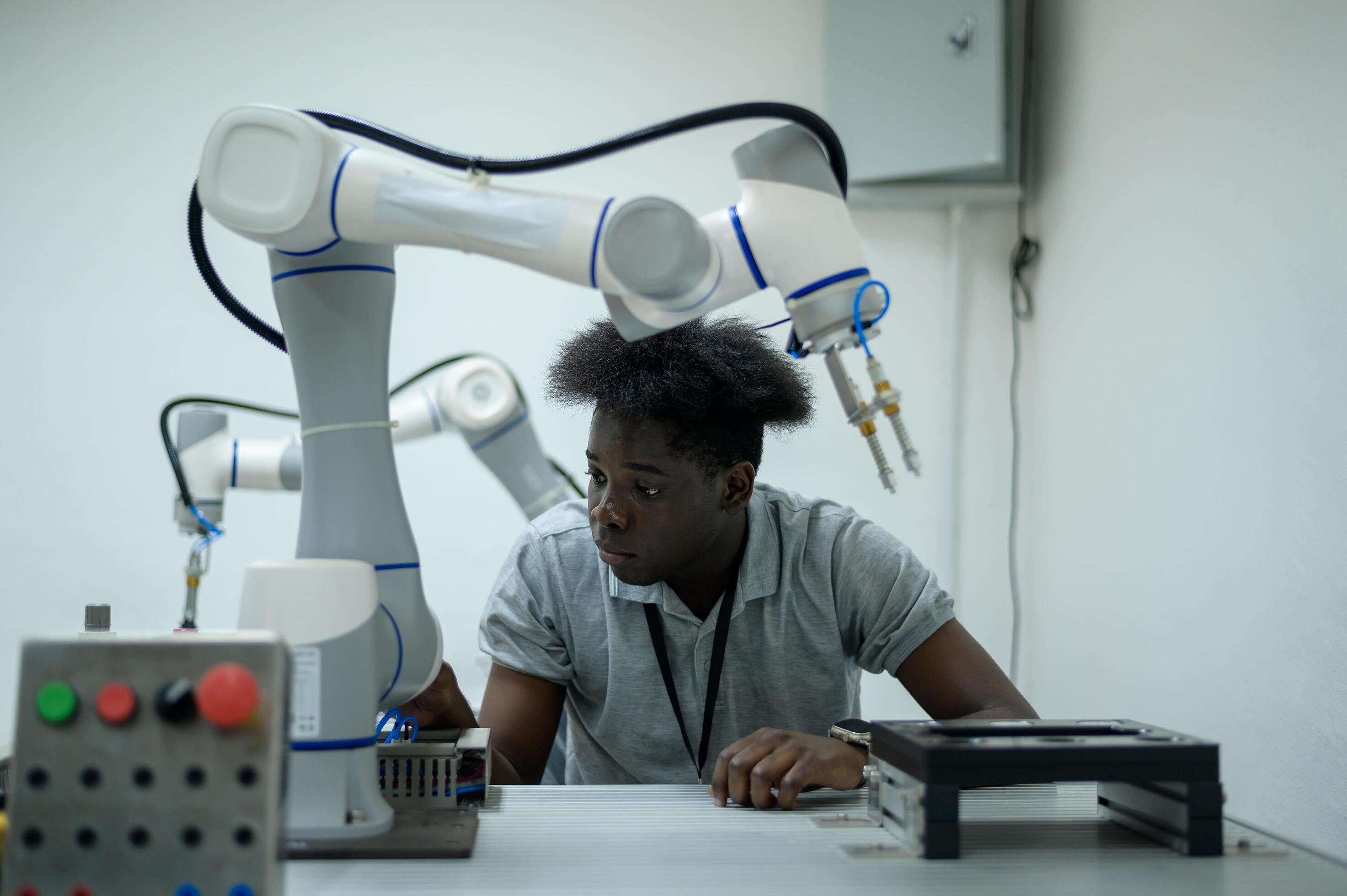 Trainee Robotics engineer learning with Programming and Manipulating Robot Hand, Industrial ...