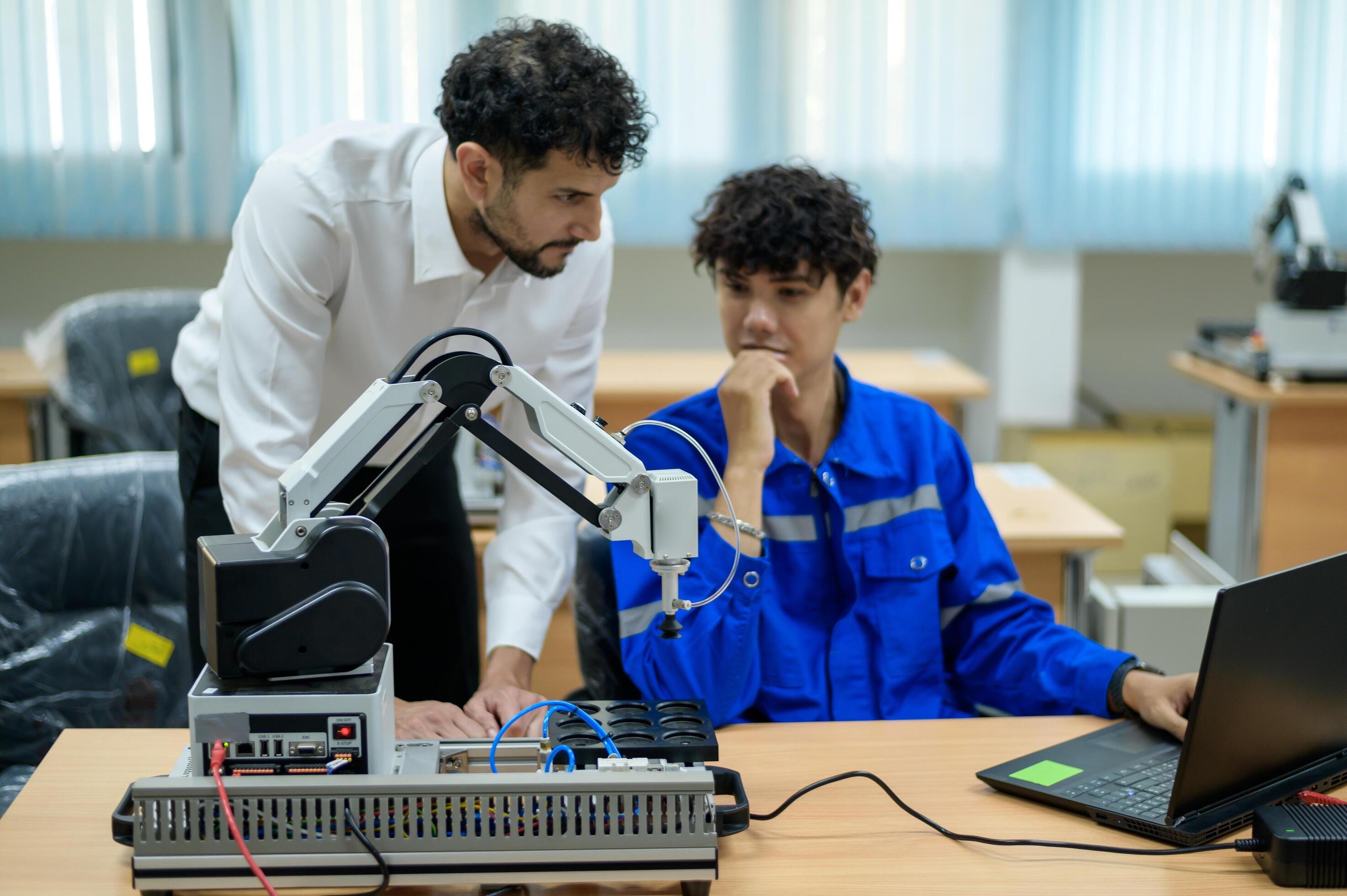 Trainee Robotics engineer learning with Programming and Manipulating Robot Hand, Industrial ...