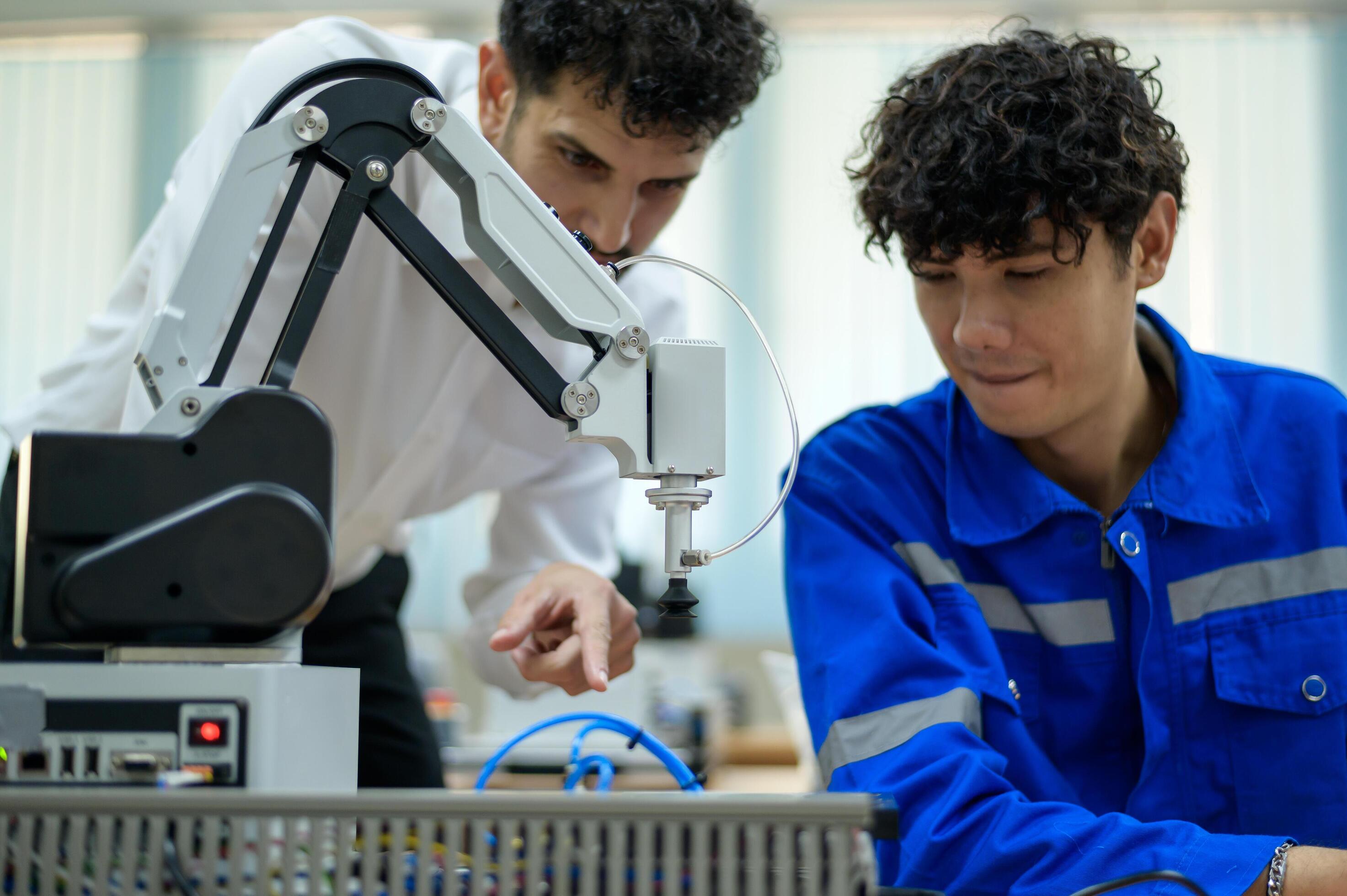 Trainee Robotics engineer learning with Programming and Manipulating Robot Hand, Industrial ...