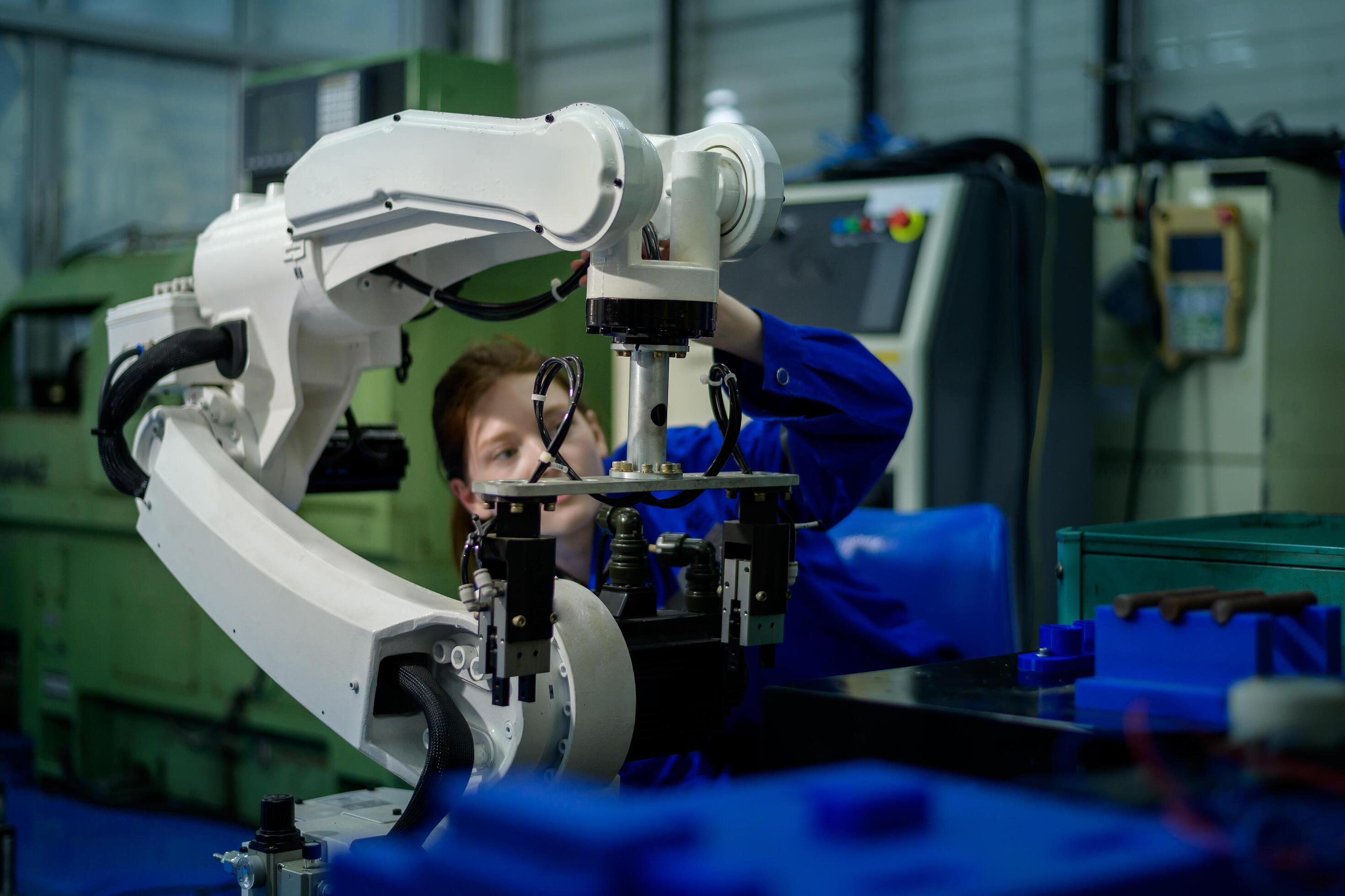 Female Robotics engineer working with Programming and Manipulating Robot Hand, Industrial ...