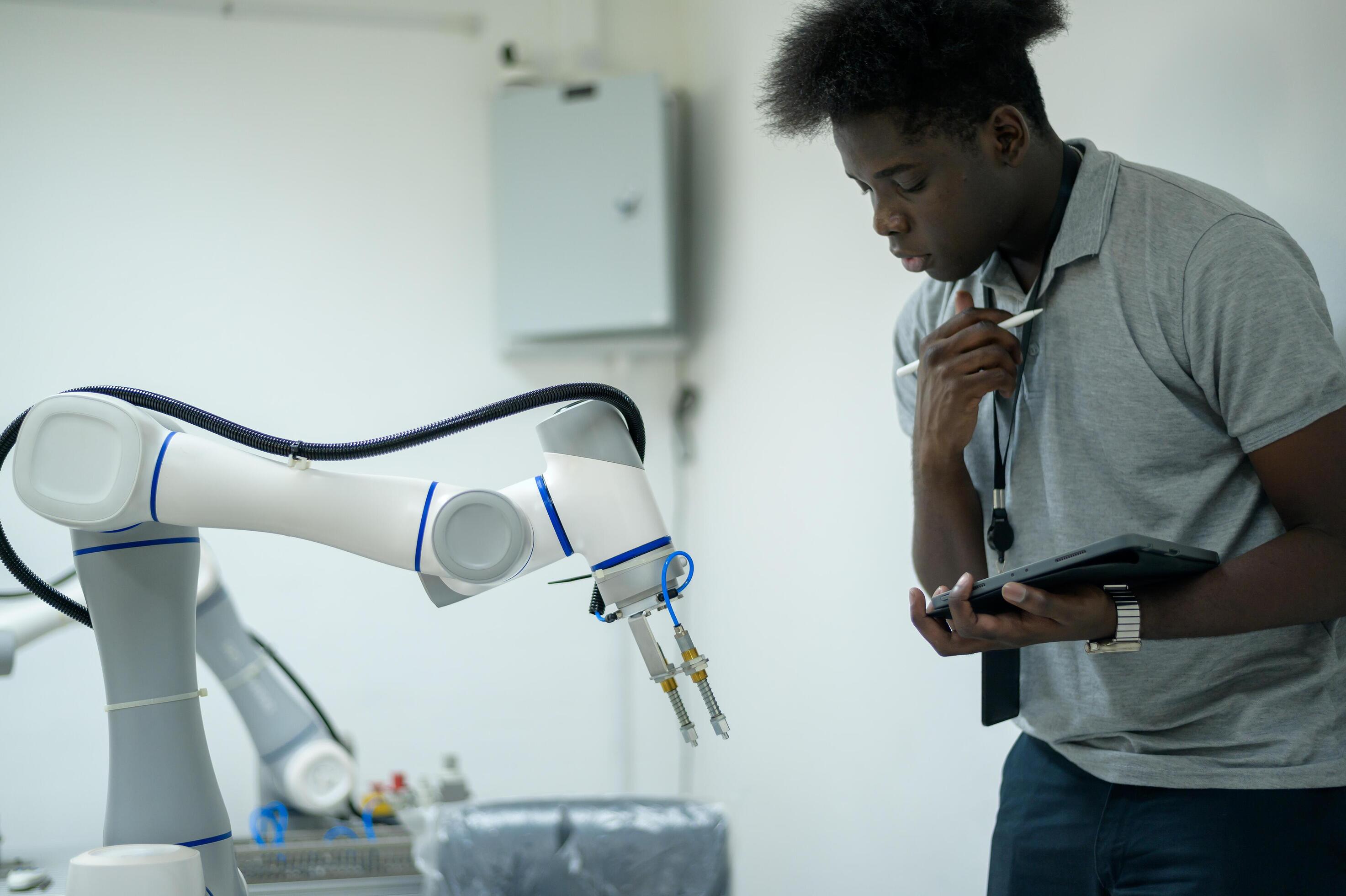 Trainee Robotics Engineer Learning With Programming And Manipulating