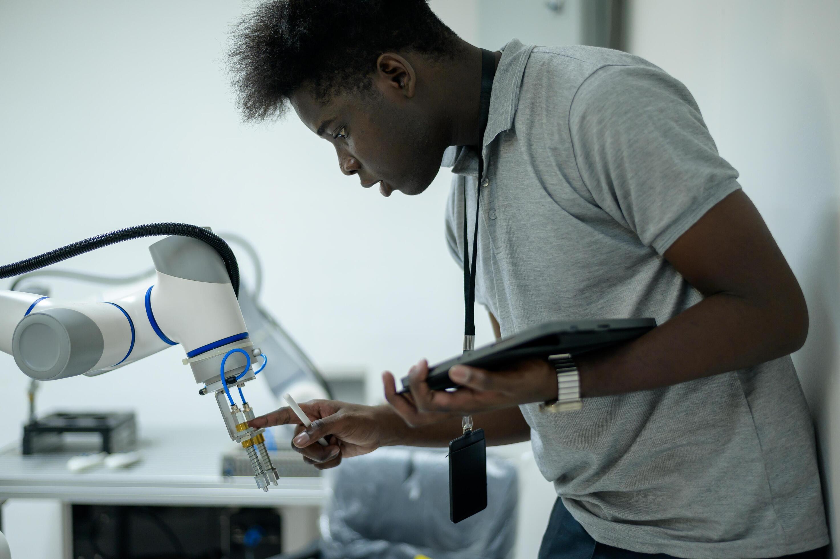 Trainee Robotics engineer learning with Programming and Manipulating Robot Hand, Industrial ...