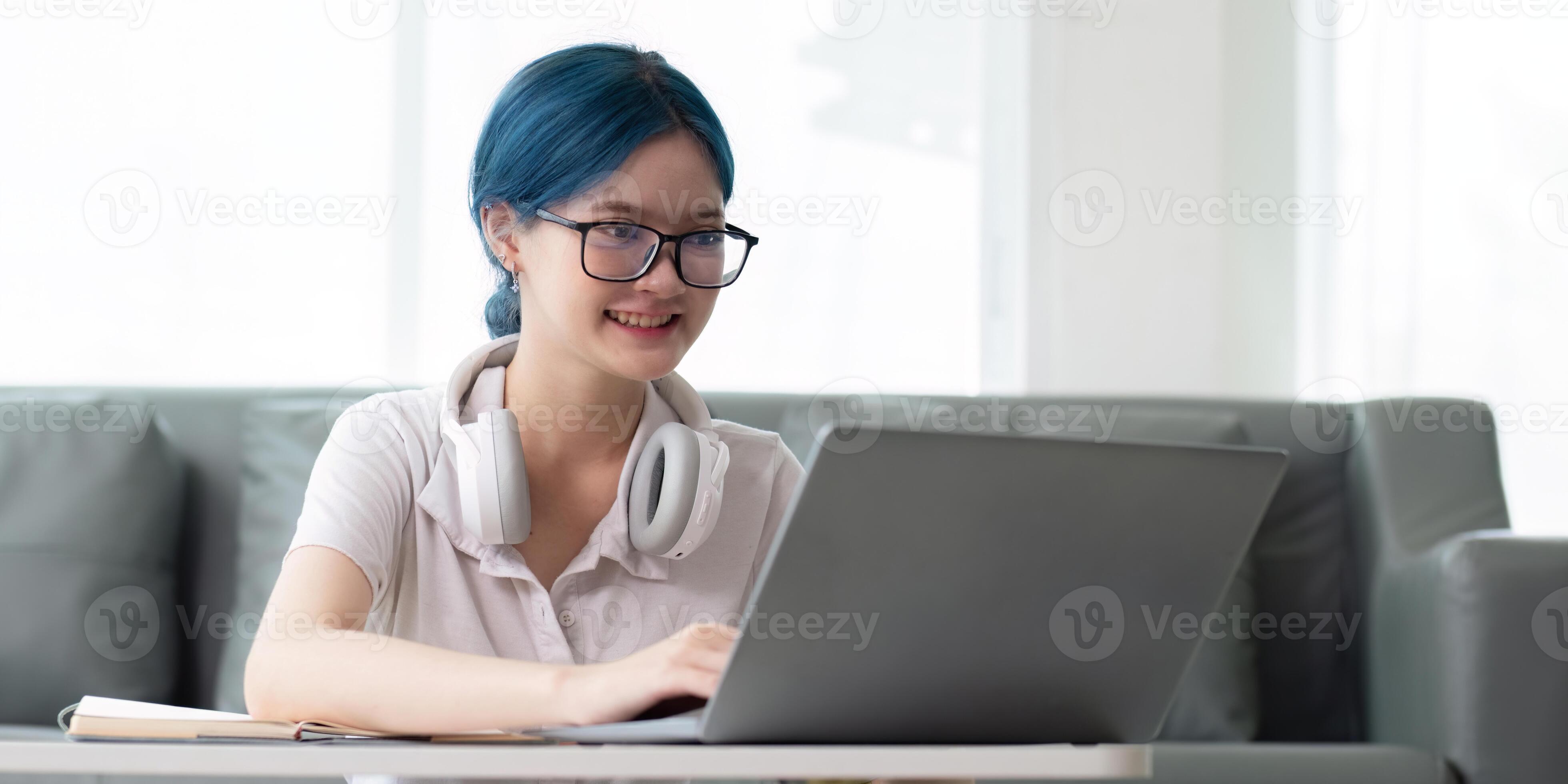 Happy young woman looking at laptop making note, girl student talking by conference call, female ...