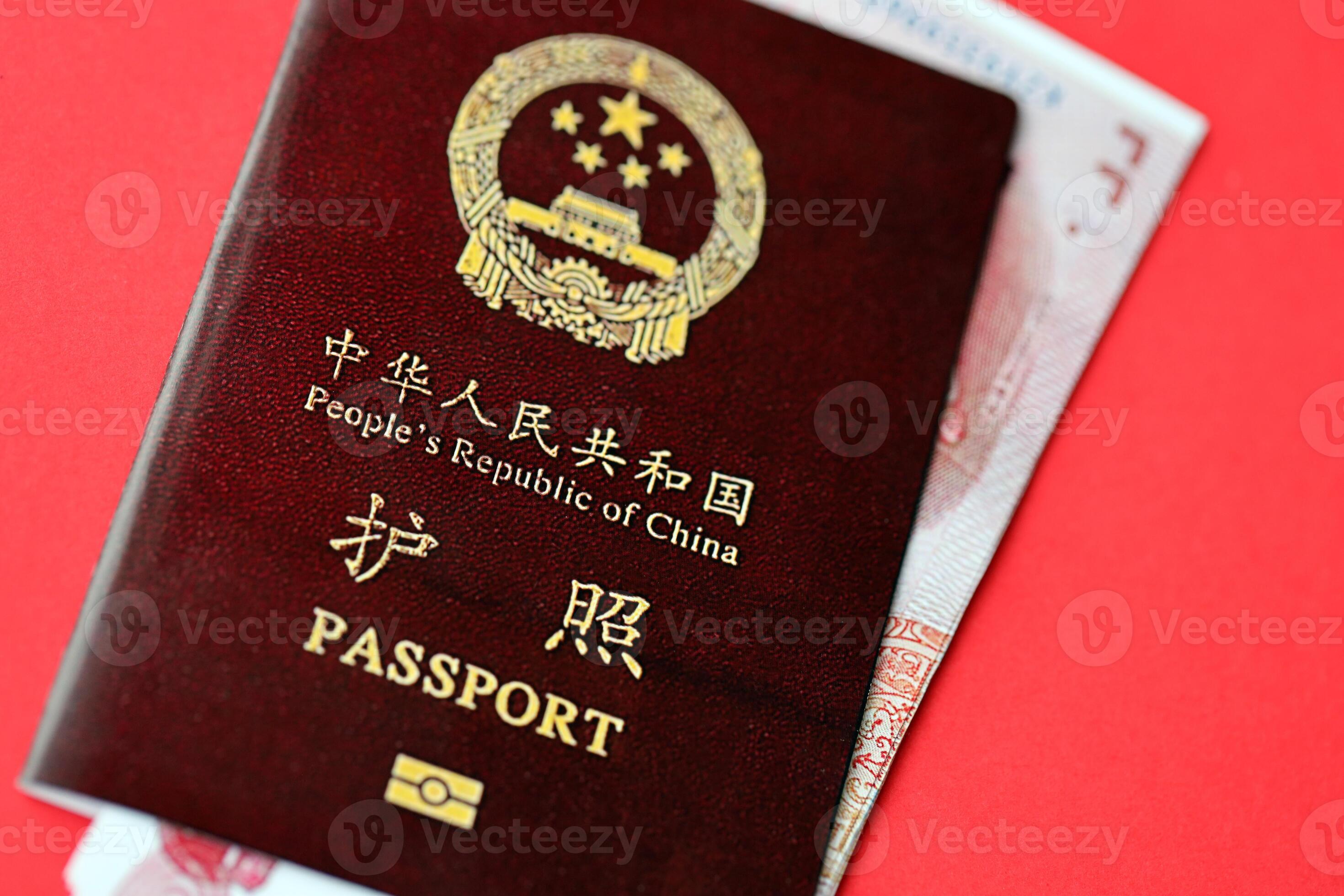 Red passport of People Republic of China and chinese yuan money bills. PRC chinese passport ...