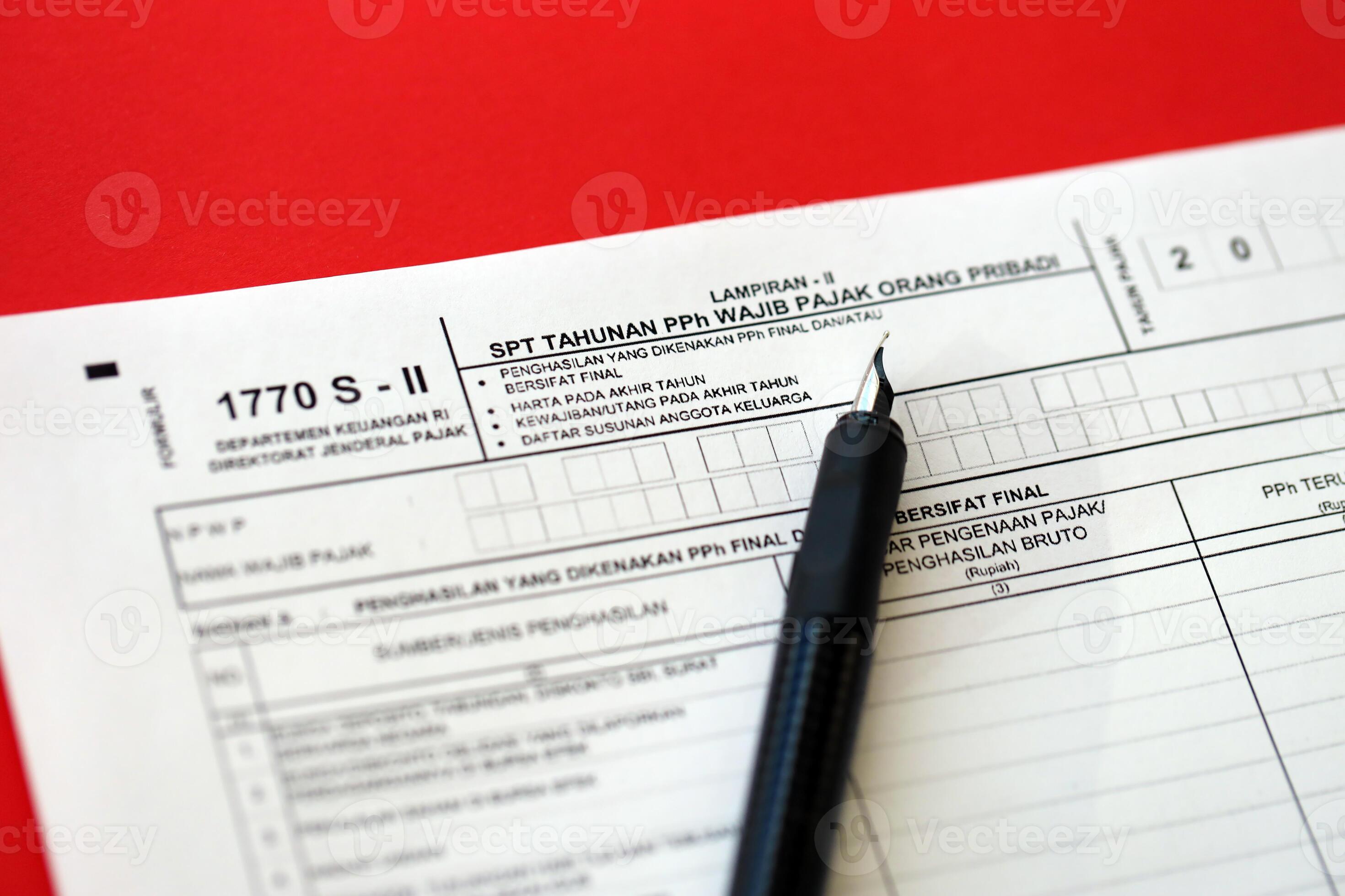Indonesian tax form 1770 S - 2 Individual Income Tax Return and pen on table 44418508 Stock ...