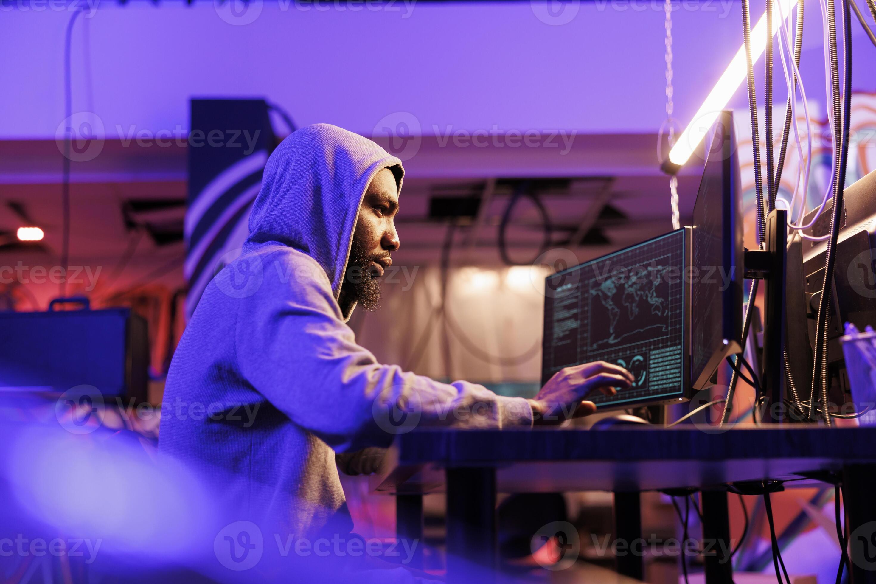 African American Hacker Stealing Sensitive Information From Server On Computer Man In Hood