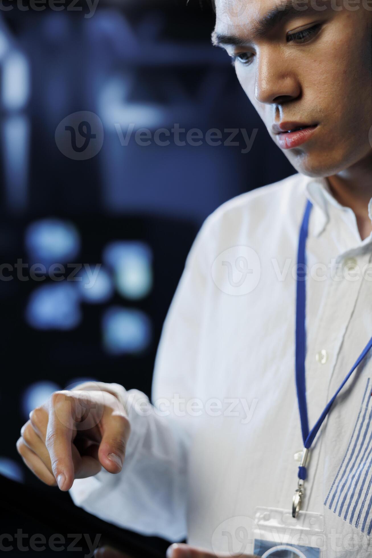 Engineer in data center using tablet to prevent system overload during ...