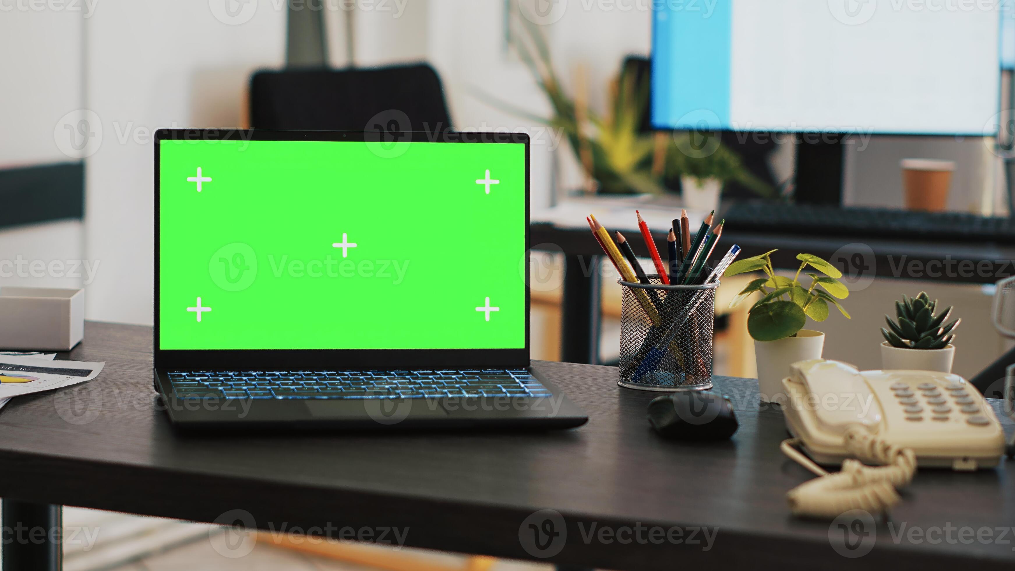 Office with isolated screen laptop and display in background with ...