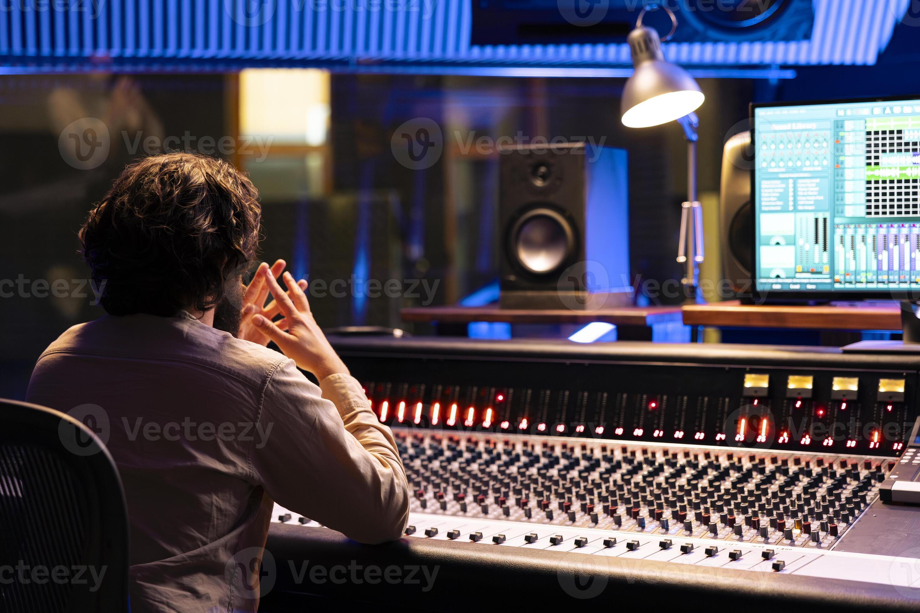 Focused Sound Designer Processing And Creating Tunes In Control Room At
