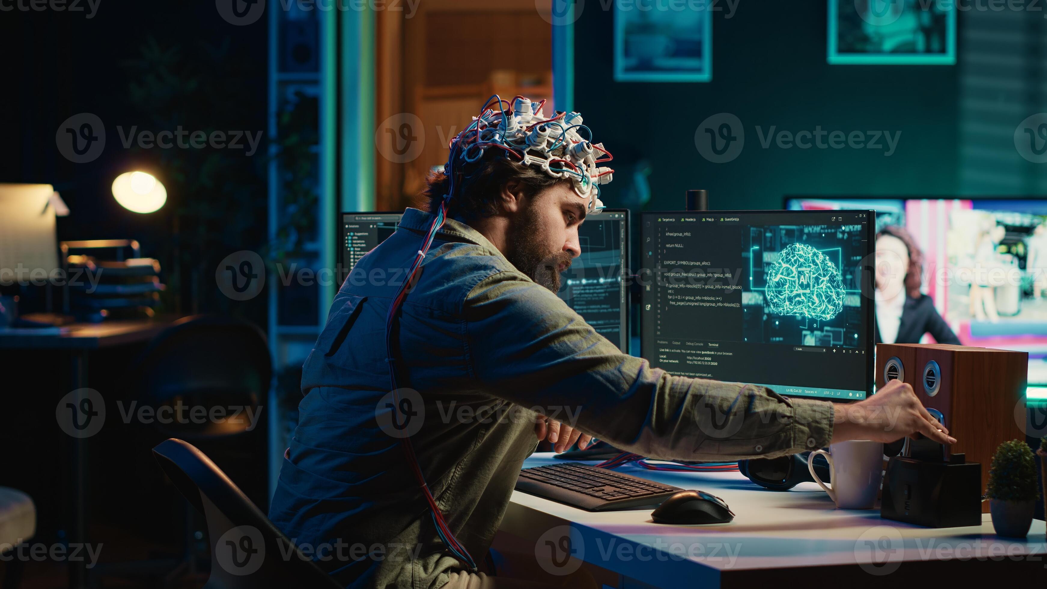 Engineer with EEG headset inserting cartridge into PC to use high tech software allowing for ...