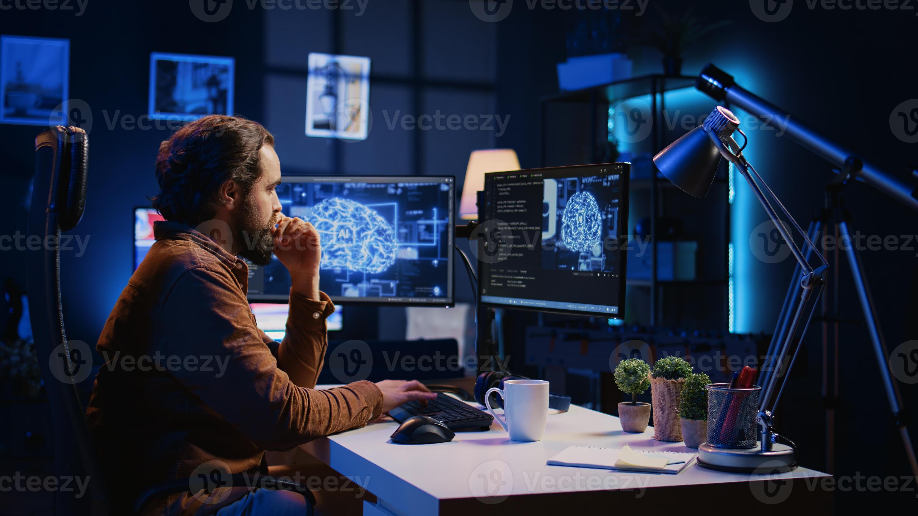 Programmer using computer to update artificial intelligence neural networks, drinking coffee and ...