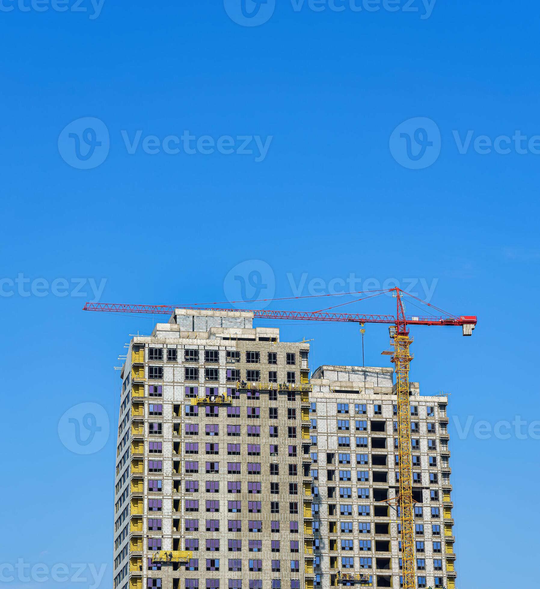 A crane building a skyscraper against a blue sky. 44440334 Stock Photo ...