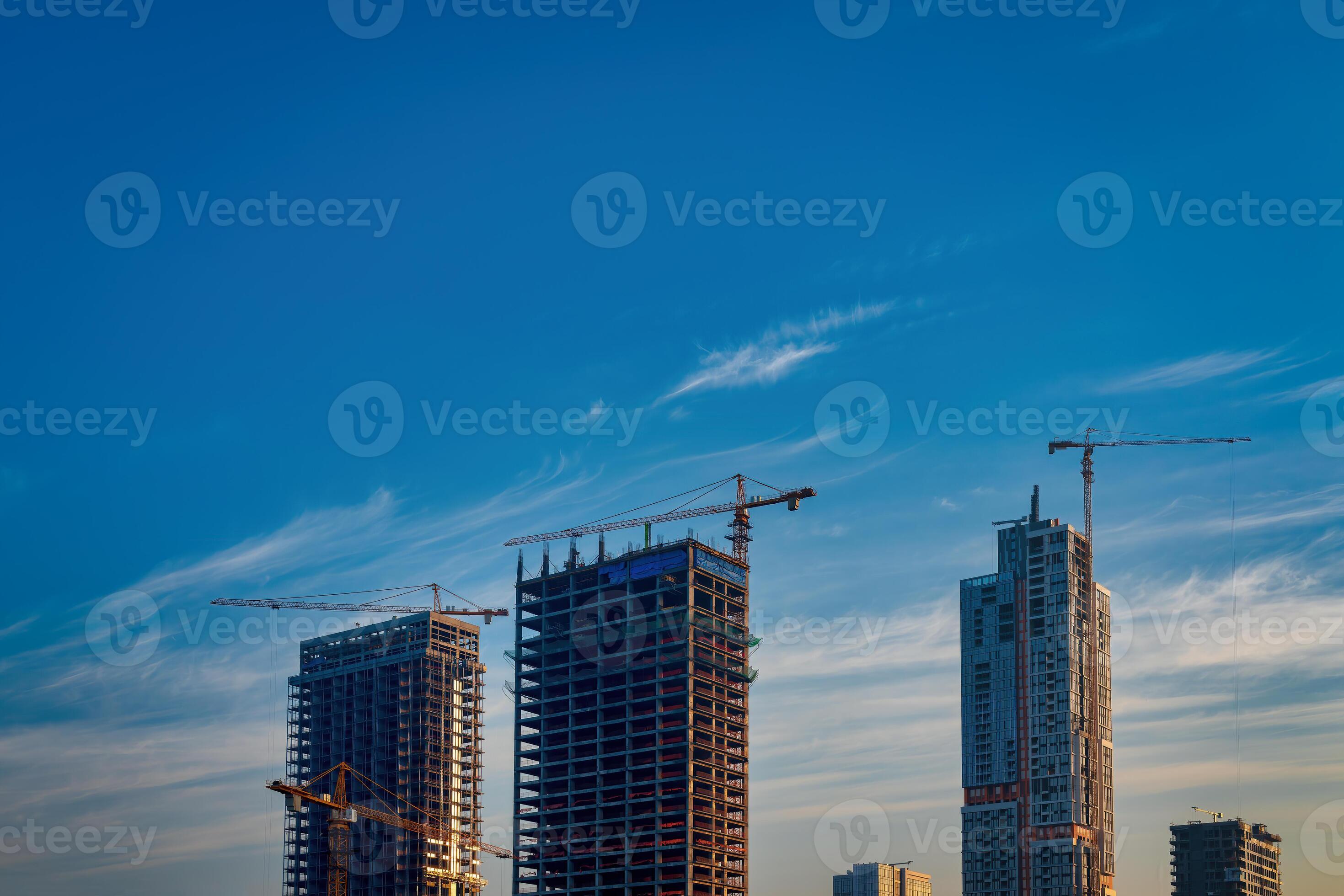 A cranes building a skyscrapers against a sunset. 44440594 Stock Photo ...