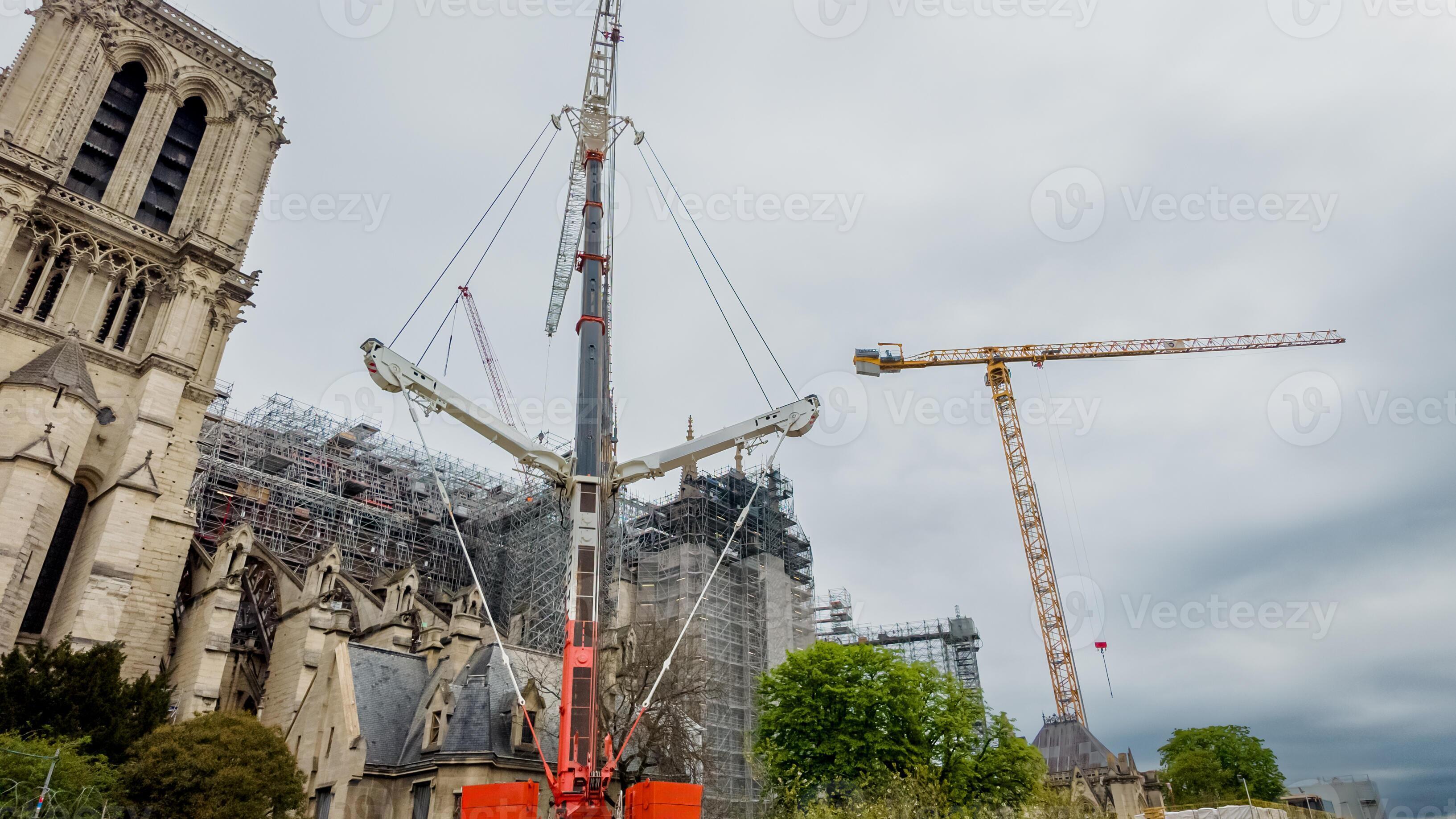 Restoration Cranes At Notre Dame Cathedral In Paris Under Cloudy Skies