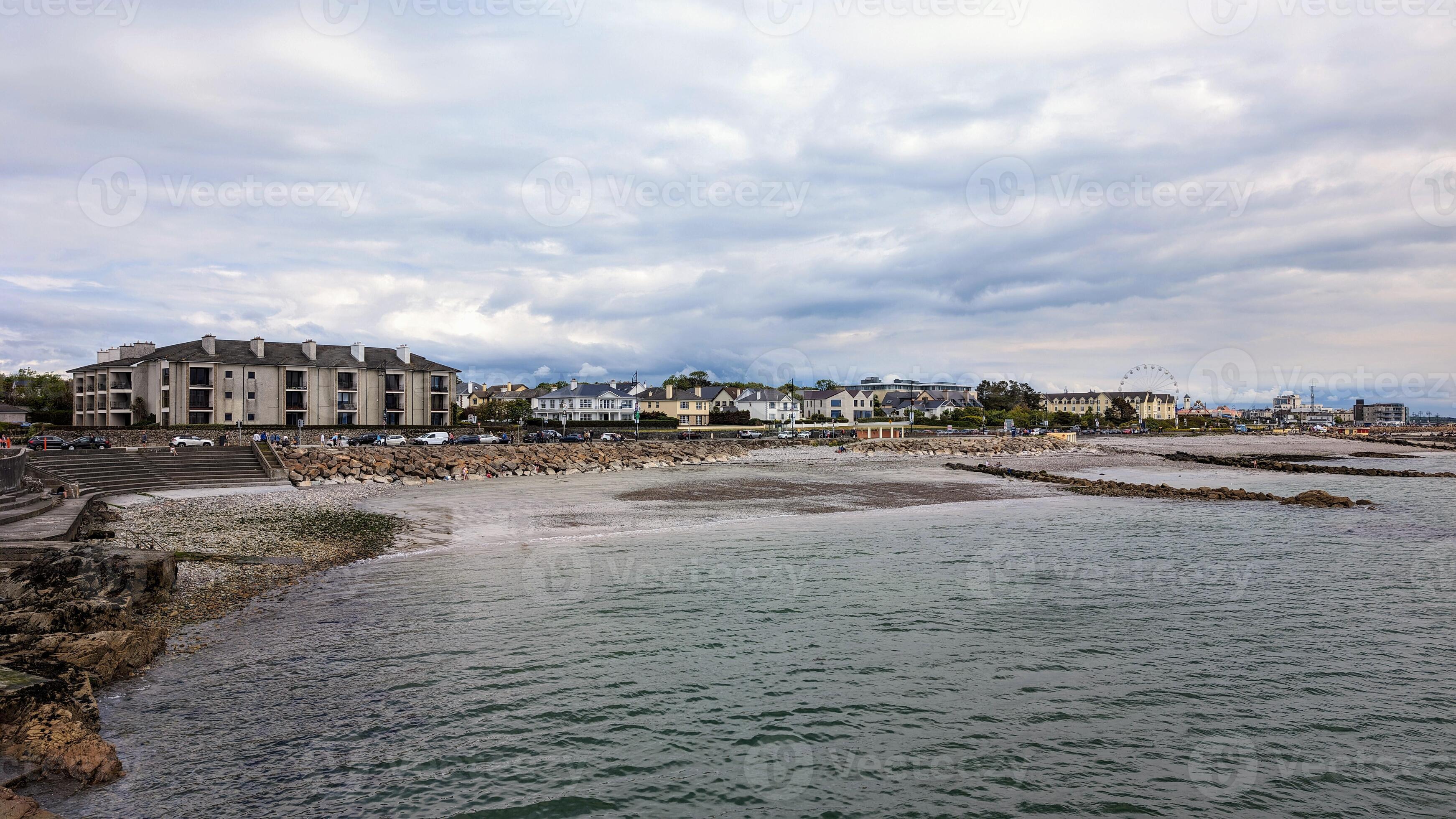 Coastal seascape, cityscape, buildings and architecture at sandy Salthill beach in Galway ...