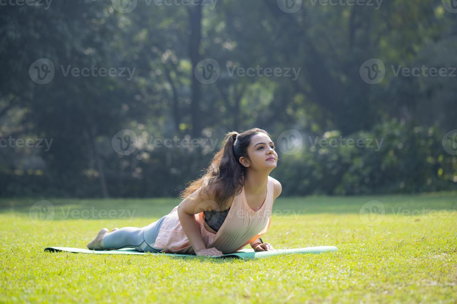 Young Pretty Woman Doing Yoga Surya Namaskar Fitness Exercise Stretching Workout In Park