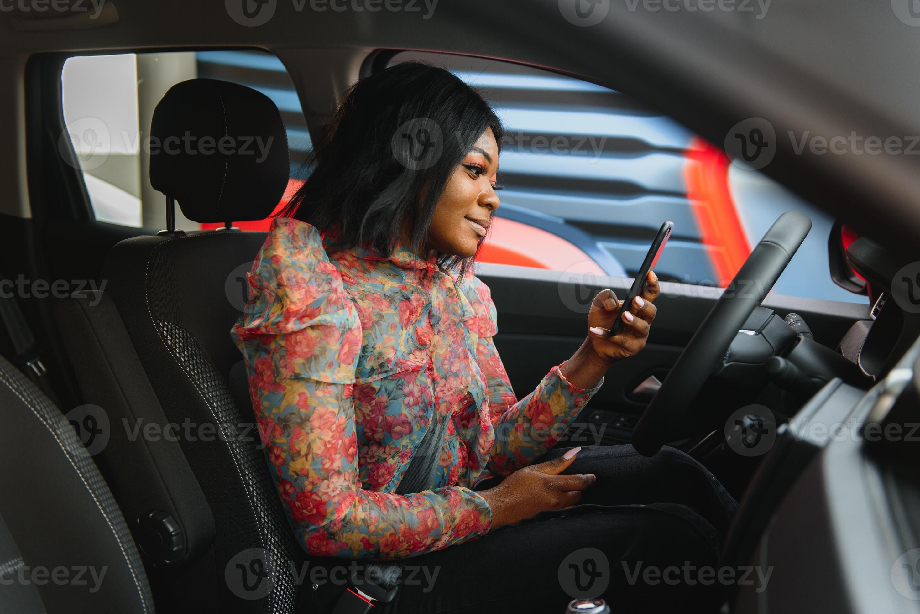 african american woman sitting in car use mobile phone texting while ...